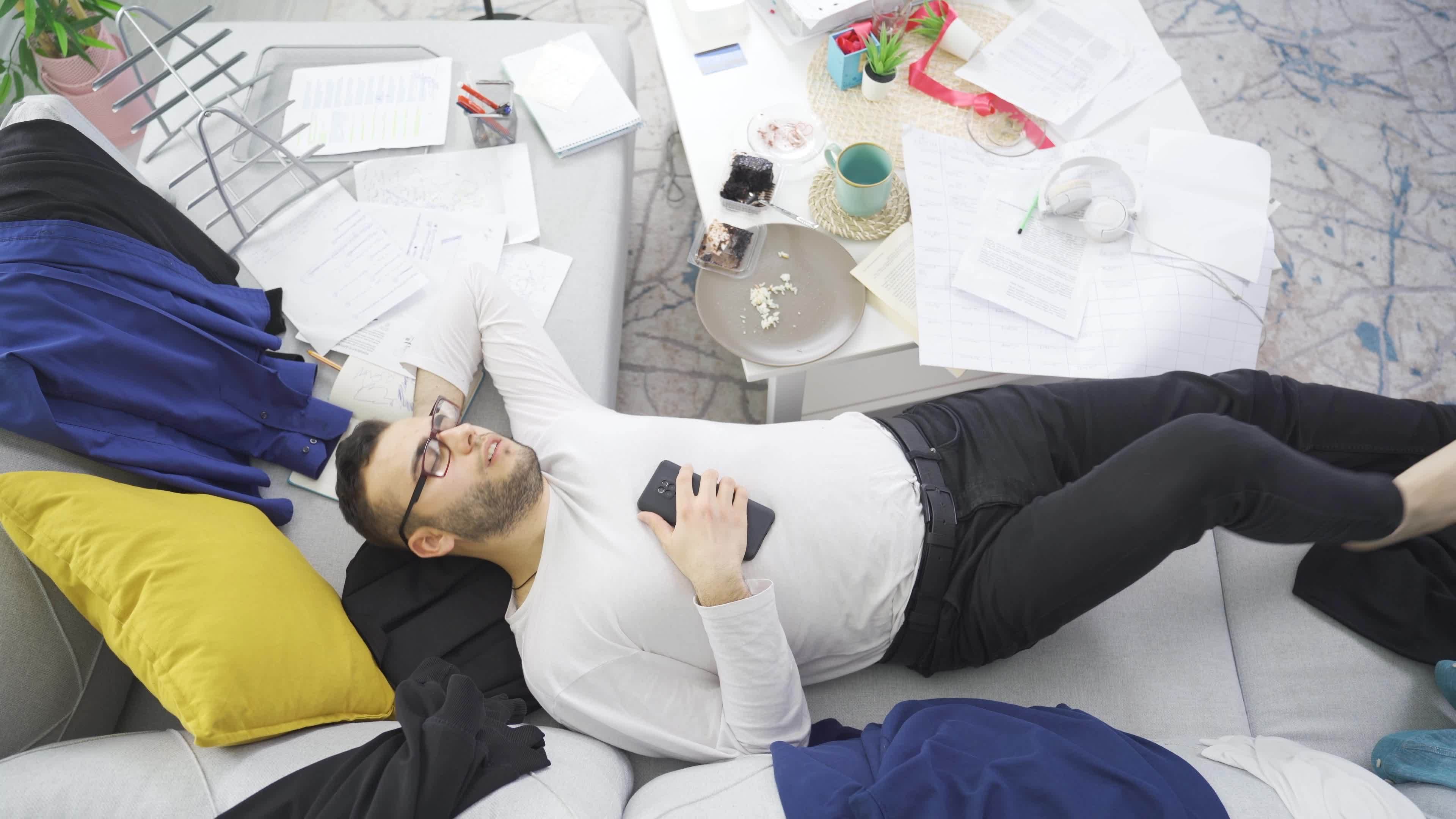 Lazy man in untidy and dirty house. Lazy man sleeping on sofa in messy ...