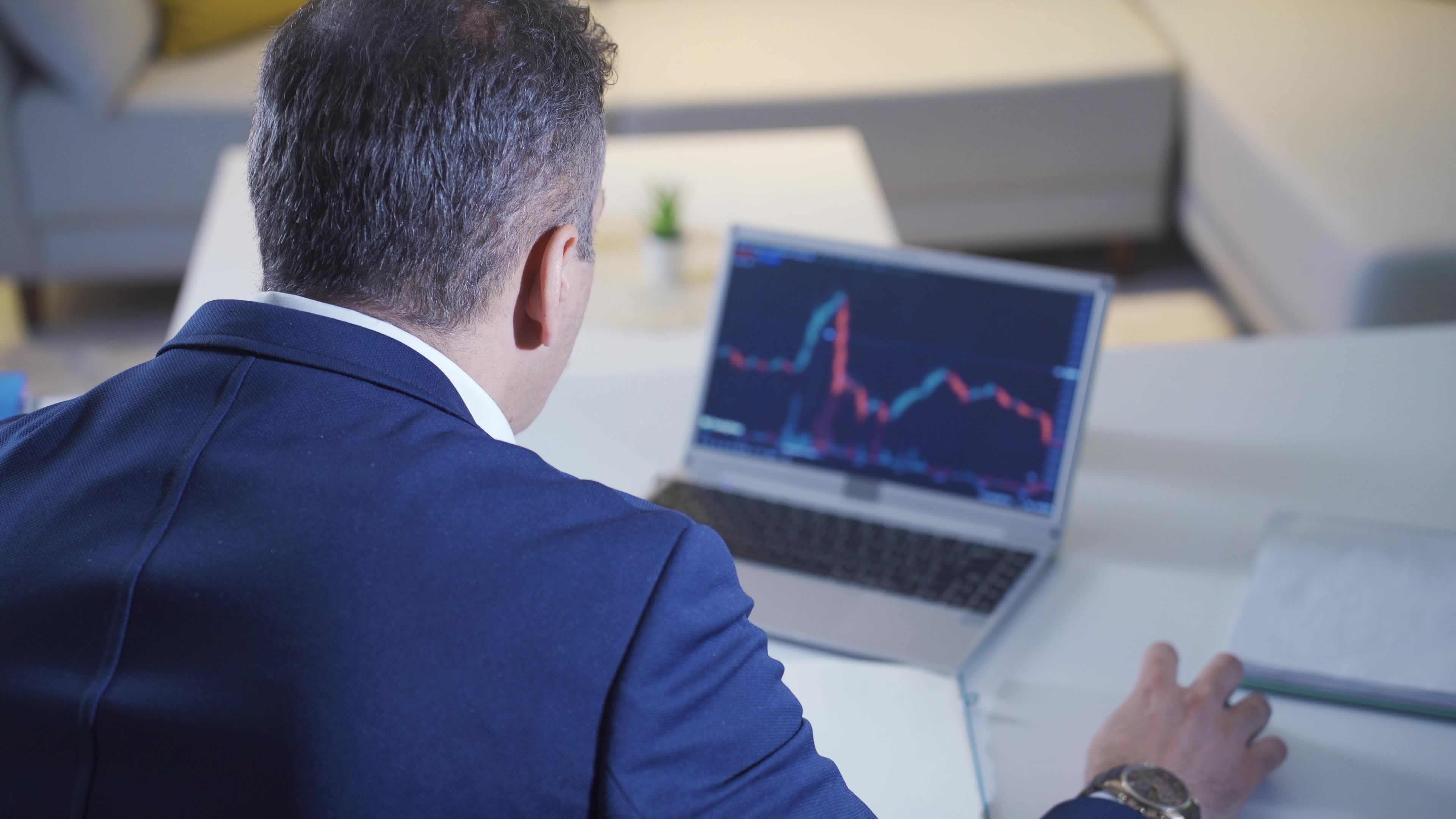 Trader Looking And Analyzing Stock Market Charts On His Laptop Man Is