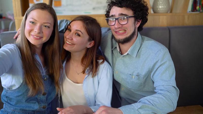 Young Friends Sit In A Cafe Drink Coffee And Have Fun Communicating Slow Motion 22749637 Stock