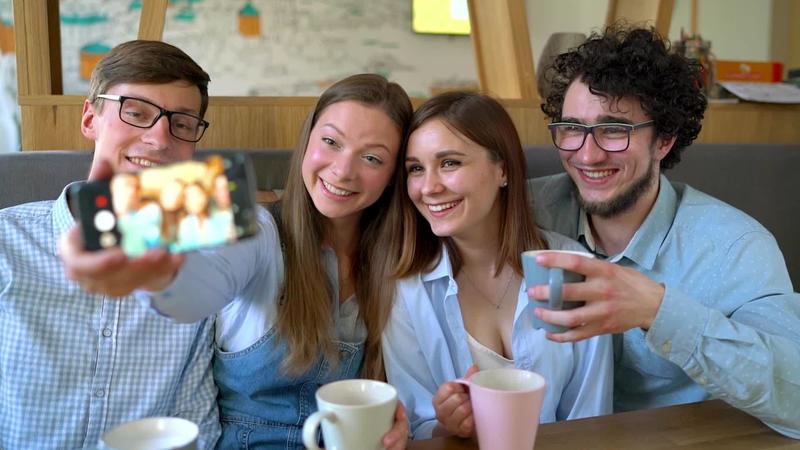 Young Friends Sit In A Cafe Drink Coffee And Have Fun Communicating Slow Motion 22749937 Stock