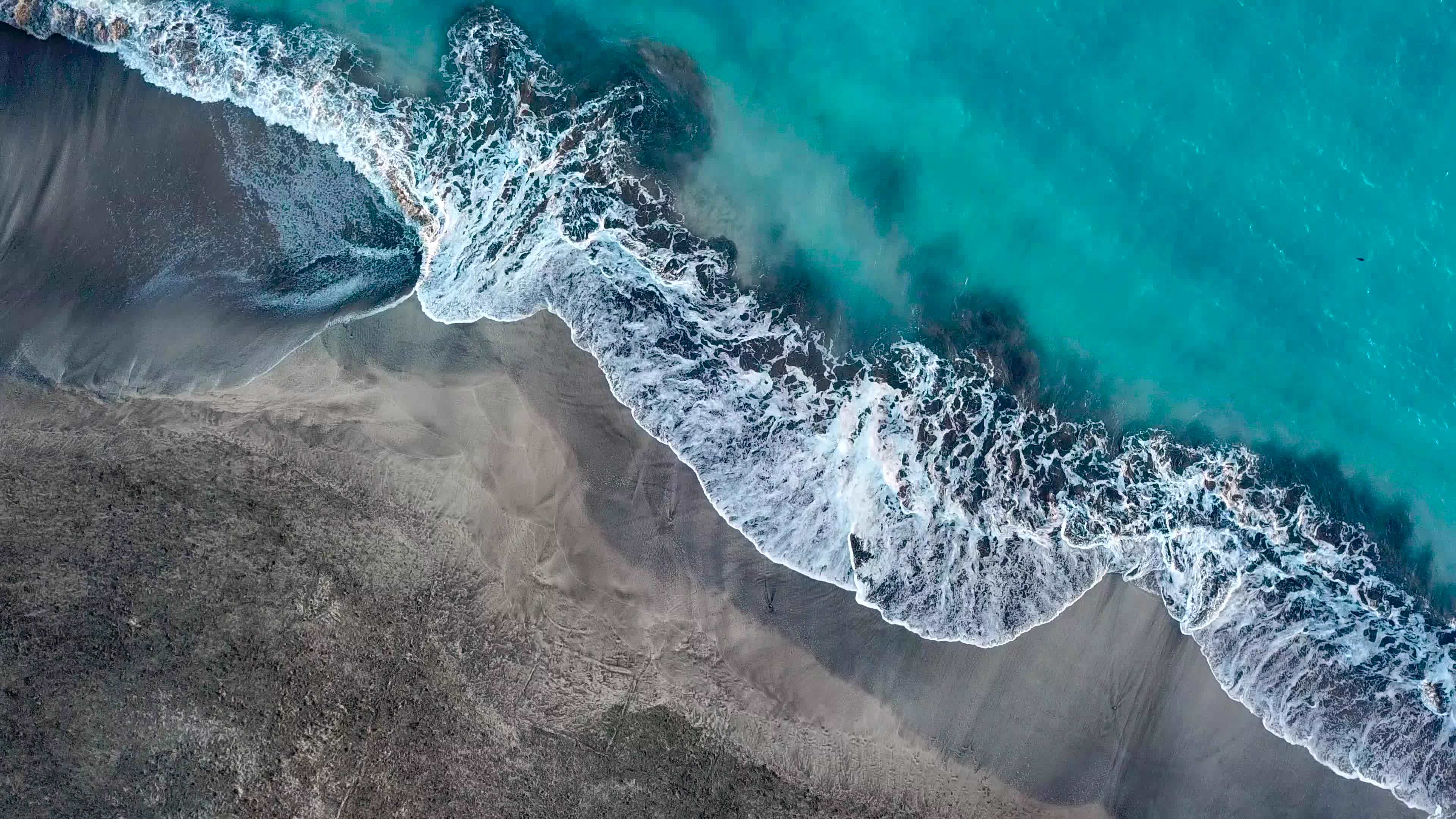 Top view of a deserted black volcanic beach. Coast of the island of ... Top view of a deserted black volcanic beach. Coast of the island of ...