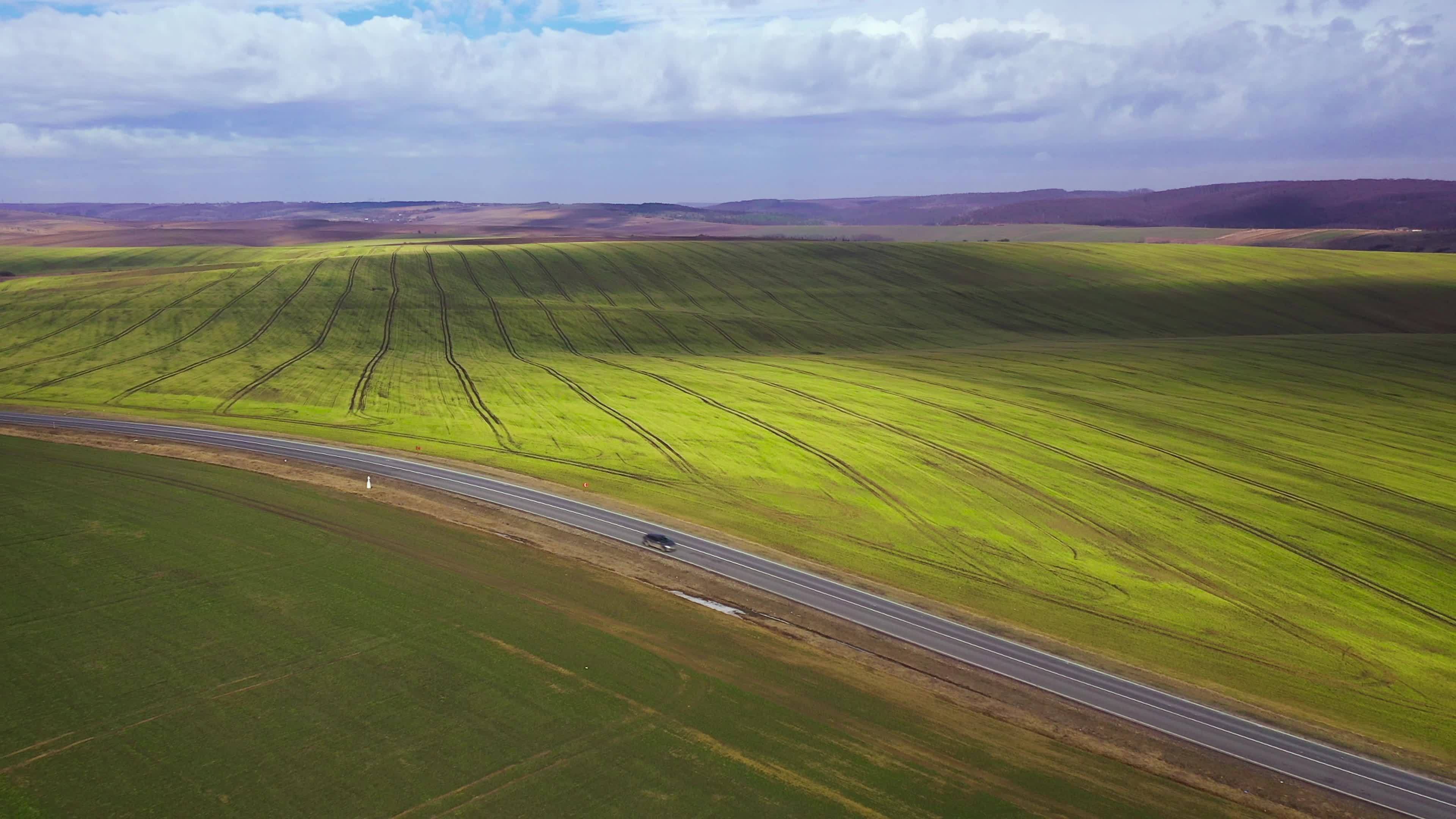Top view of a cars driving along a rural road between two fields ... Top view of a cars driving along a rural road between two fields ...