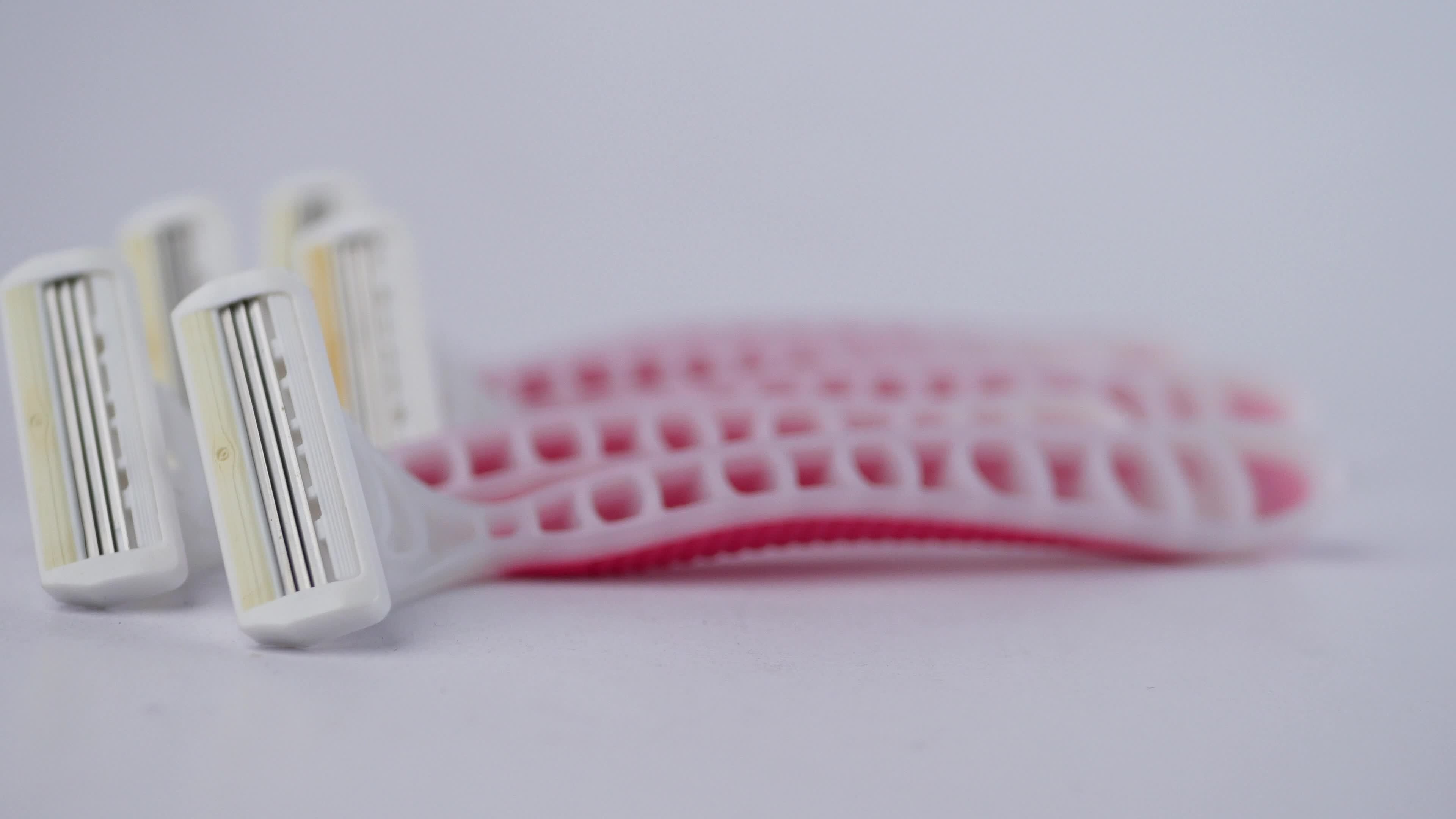 close up of pink color razor on table , 22911323 Stock Video at Vecteezy