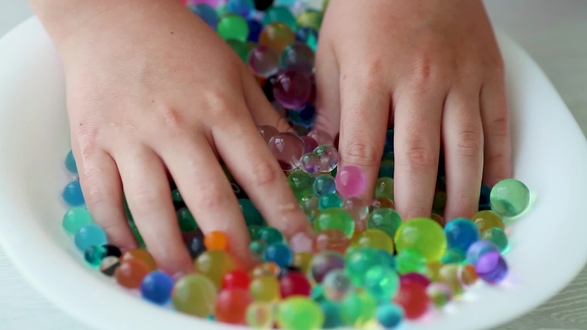 Children is hands play orbeez in a plate. Decoration with water balls hydrogel - orbeez ...