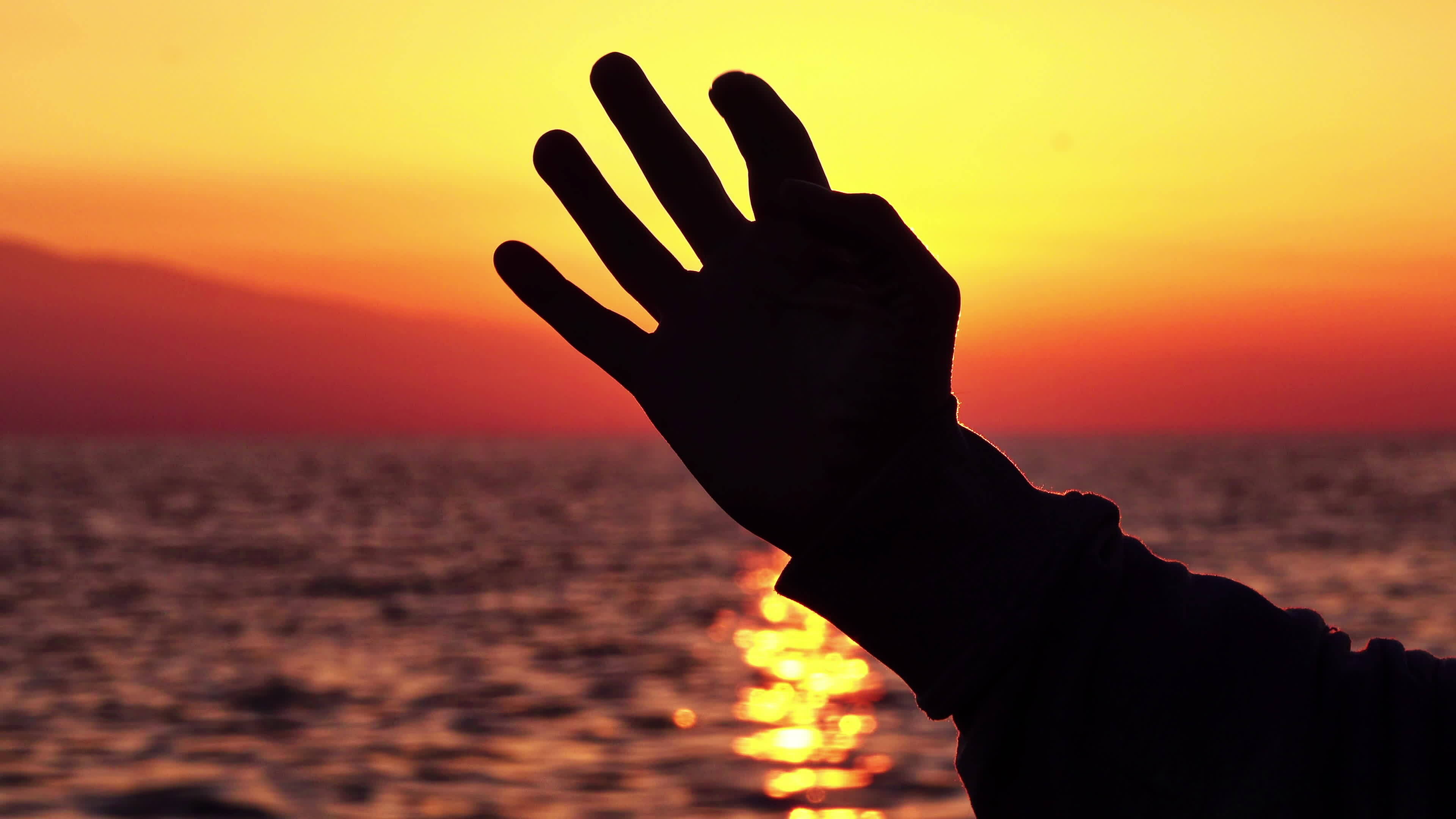 Man Hand Finger Touching the Sun at Sea Sunset 23174455 Stock Video at Vecteezy