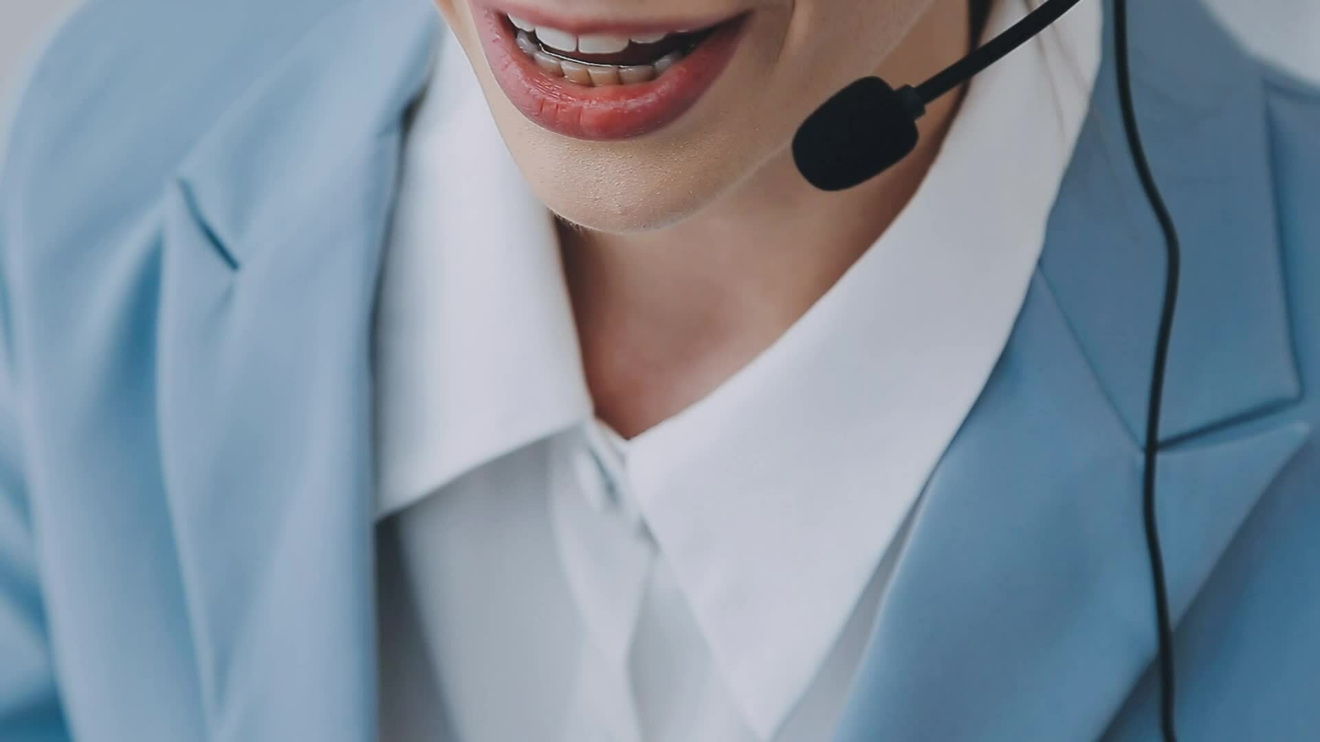 Call center agent with headset working on support hotline in modern office with copy space ...