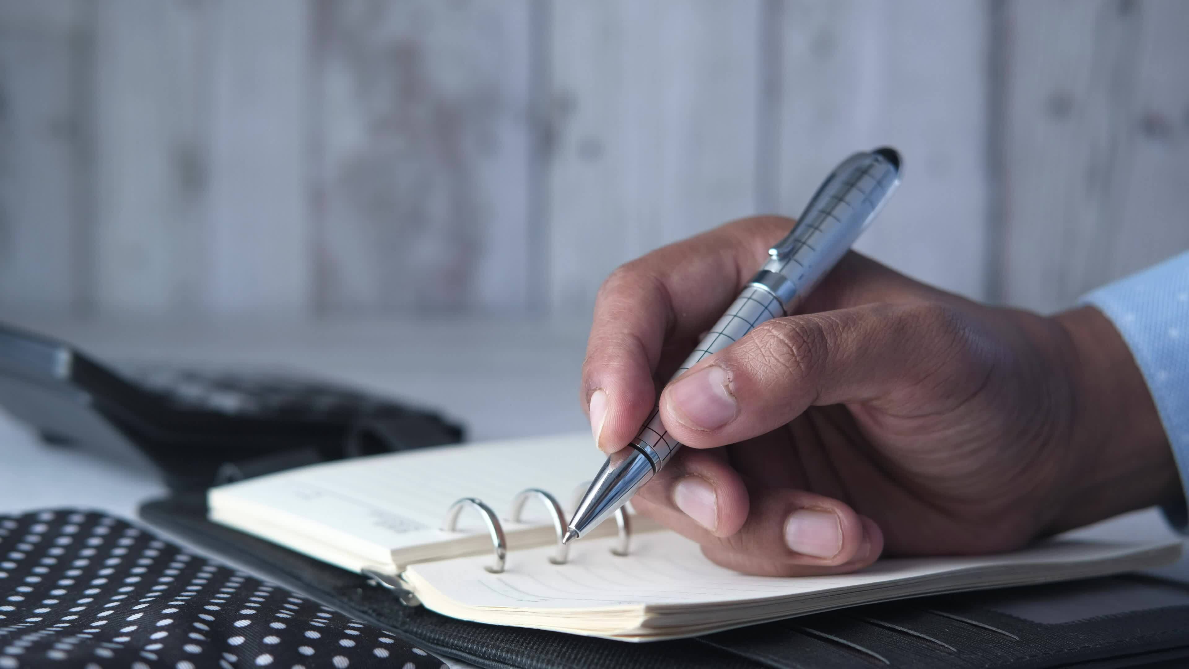 Close up of man hand writing on notepad 23358863 Stock Video at Vecteezy