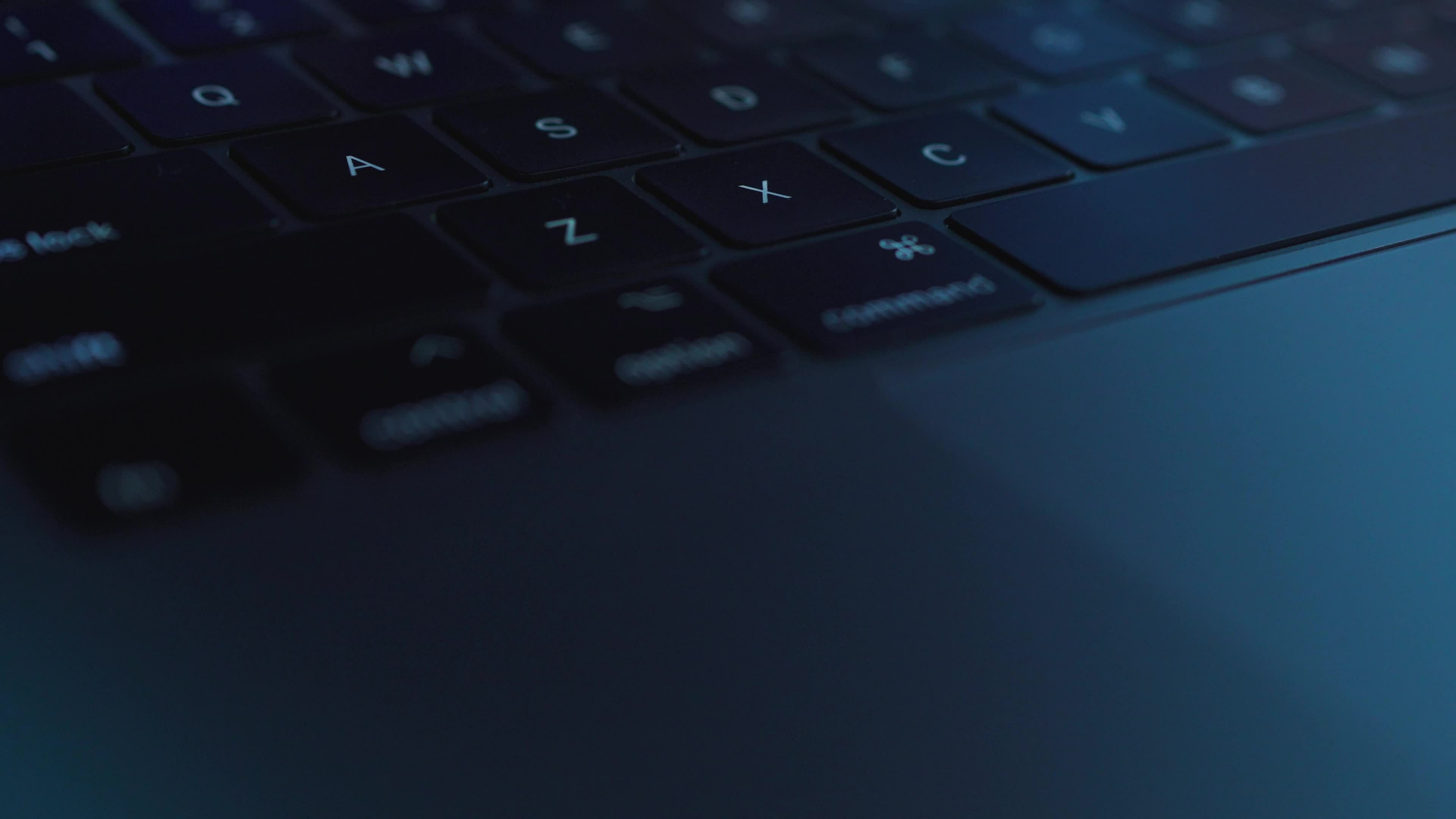 Close up laptop keyboard with multi-colored highlights on it. Very ...