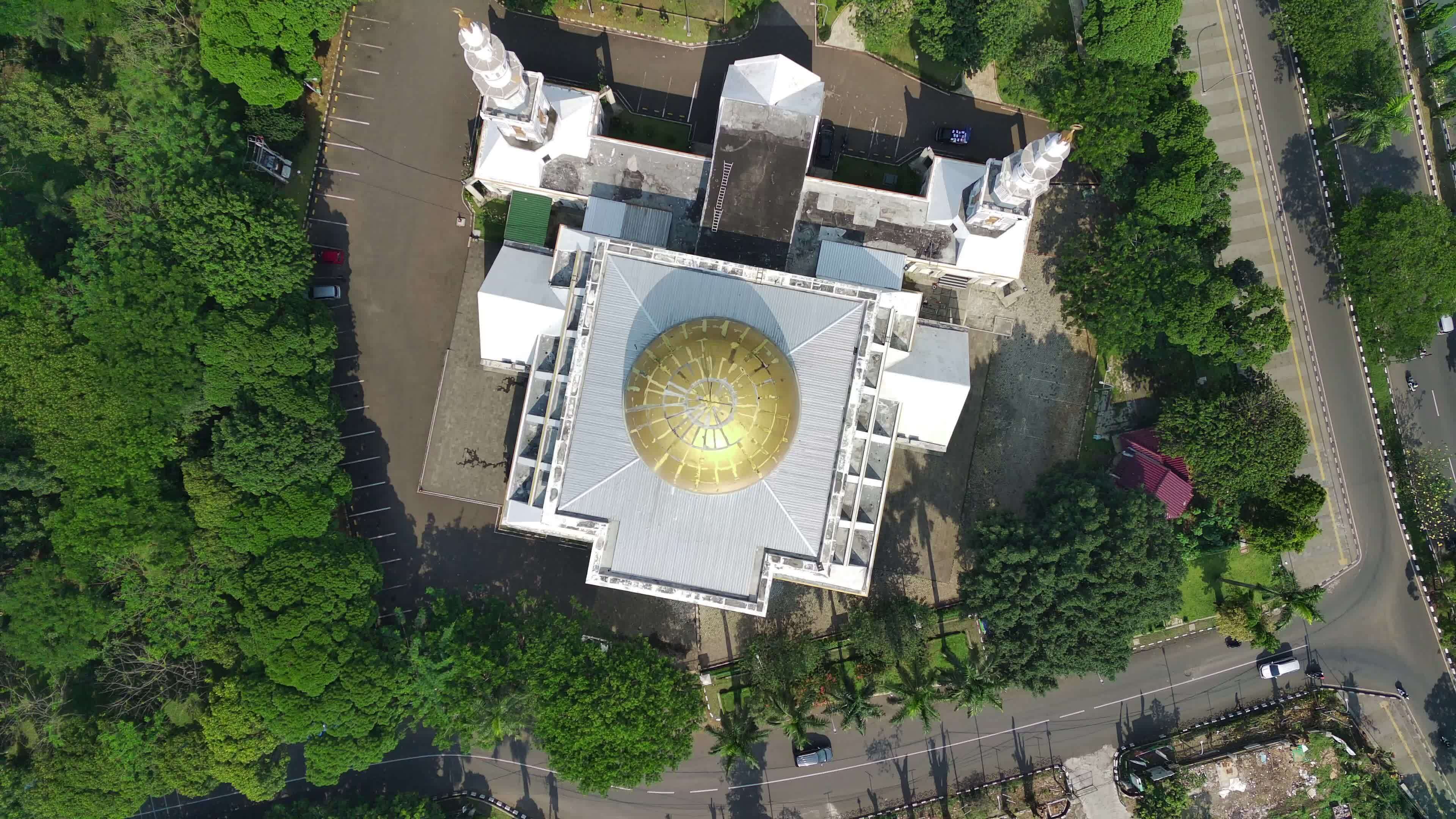 4K footage aerial view of the Baitul Faidzin Grand Mosque at noon in the middle of the central ...