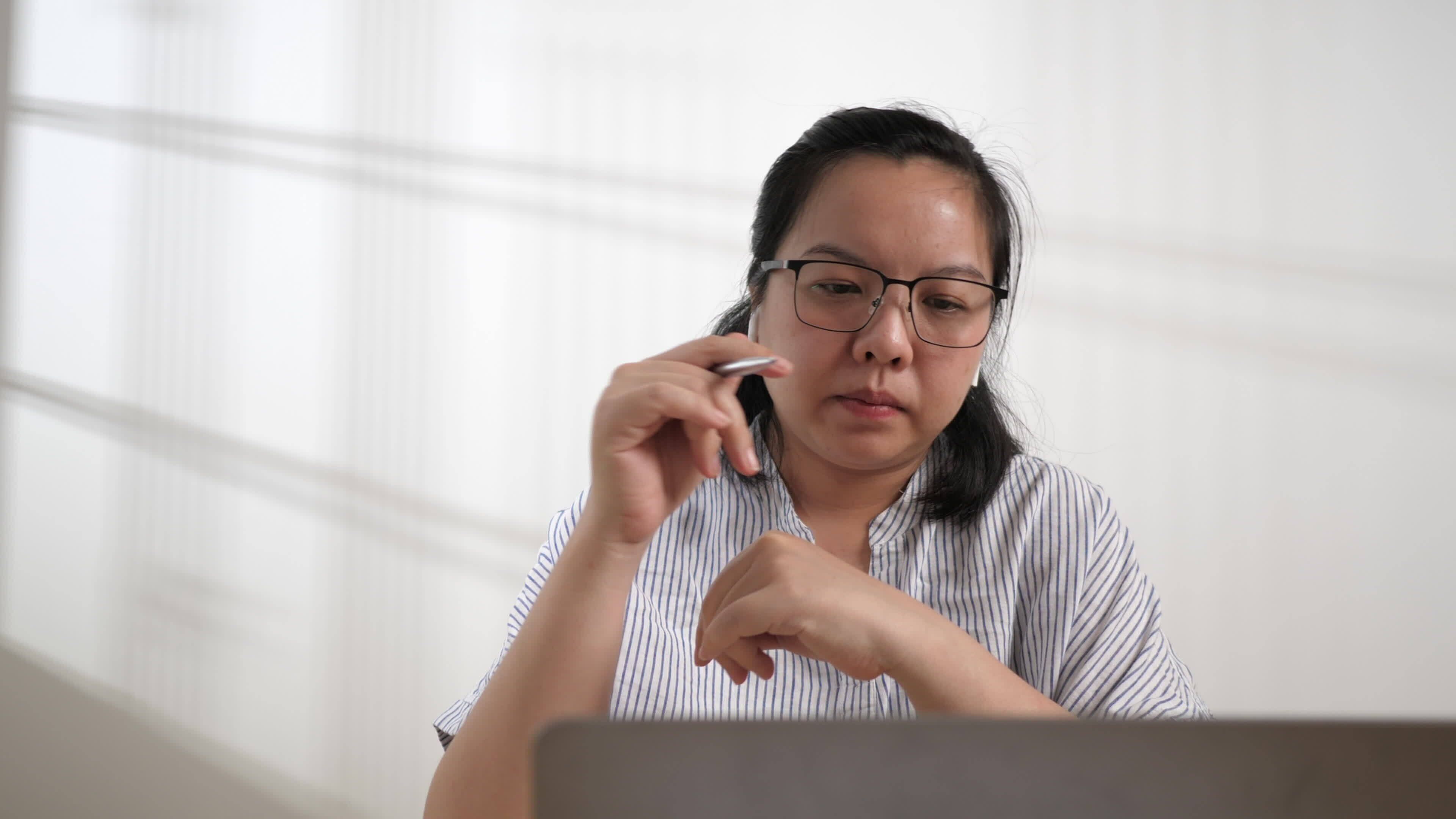 Footage of young Asian woman, freelance data scientist work remotely at ...