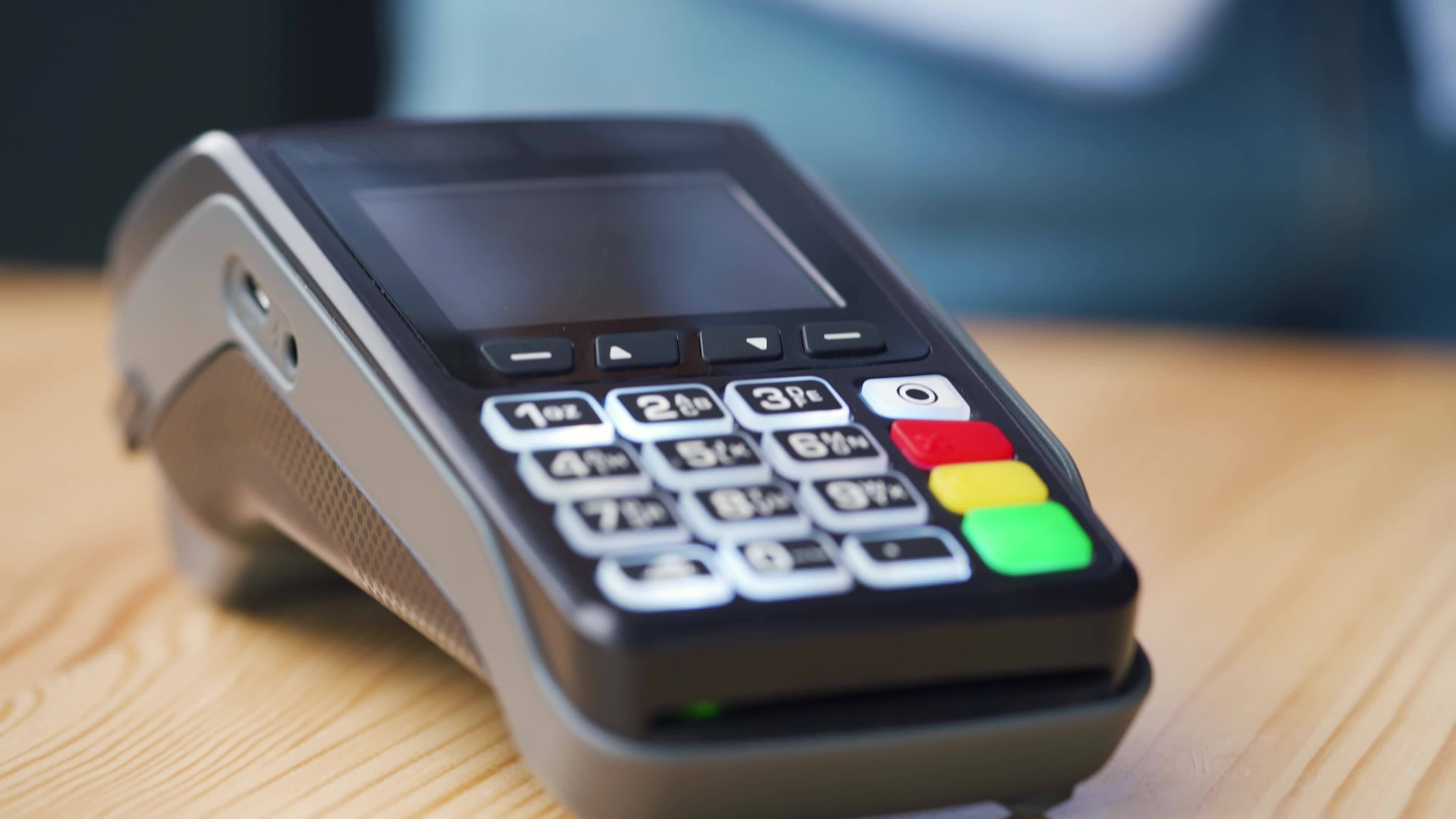 NFC credit card payment. Woman paying with contactless credit card with ... NFC credit card payment. Woman paying with contactless credit card with ...