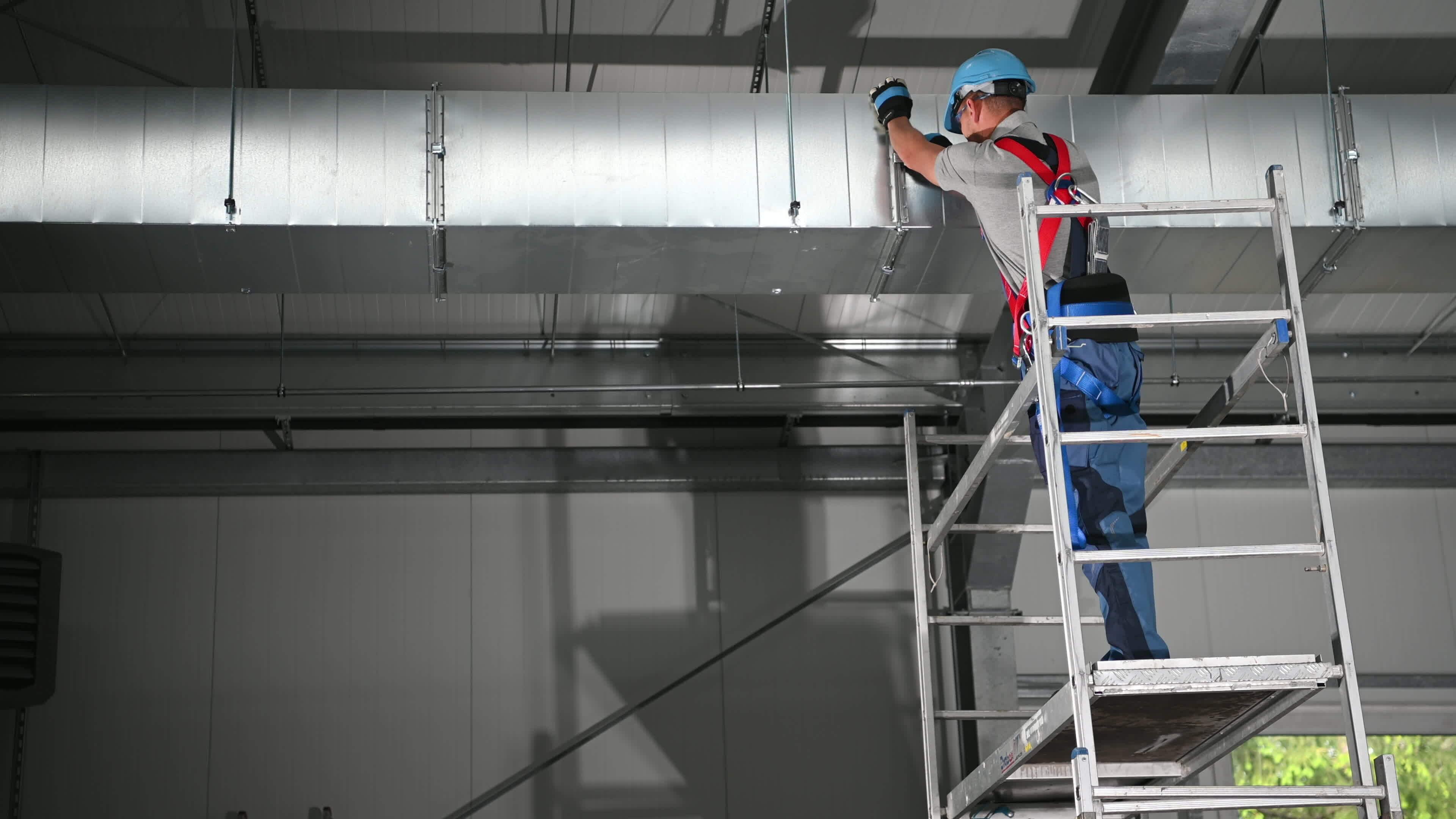 Caucasian Male Hvac Contractor Fastening Metal Clamps On Air ...