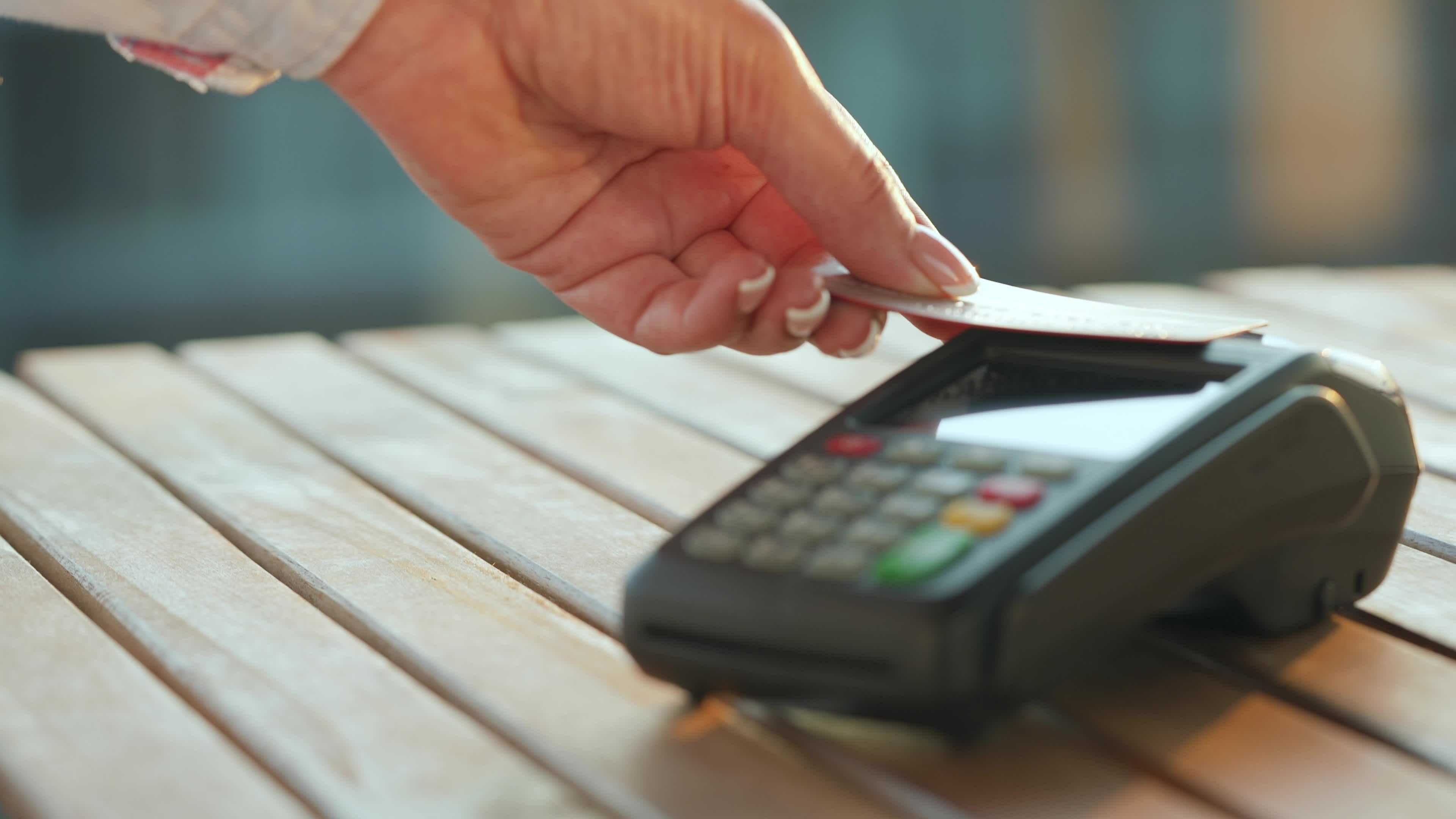 NFC credit card payment. Woman paying with contactless credit card with ... NFC credit card payment. Woman paying with contactless credit card with ...