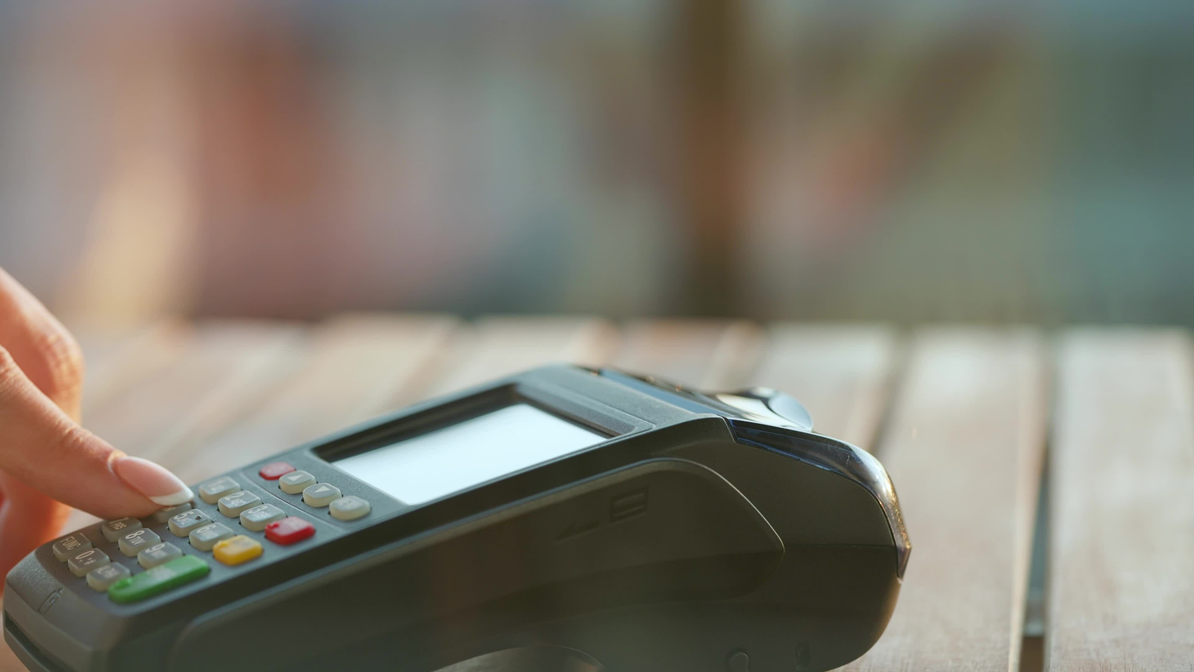 NFC credit card payment. Woman paying with contactless credit card with ... NFC credit card payment. Woman paying with contactless credit card with ...