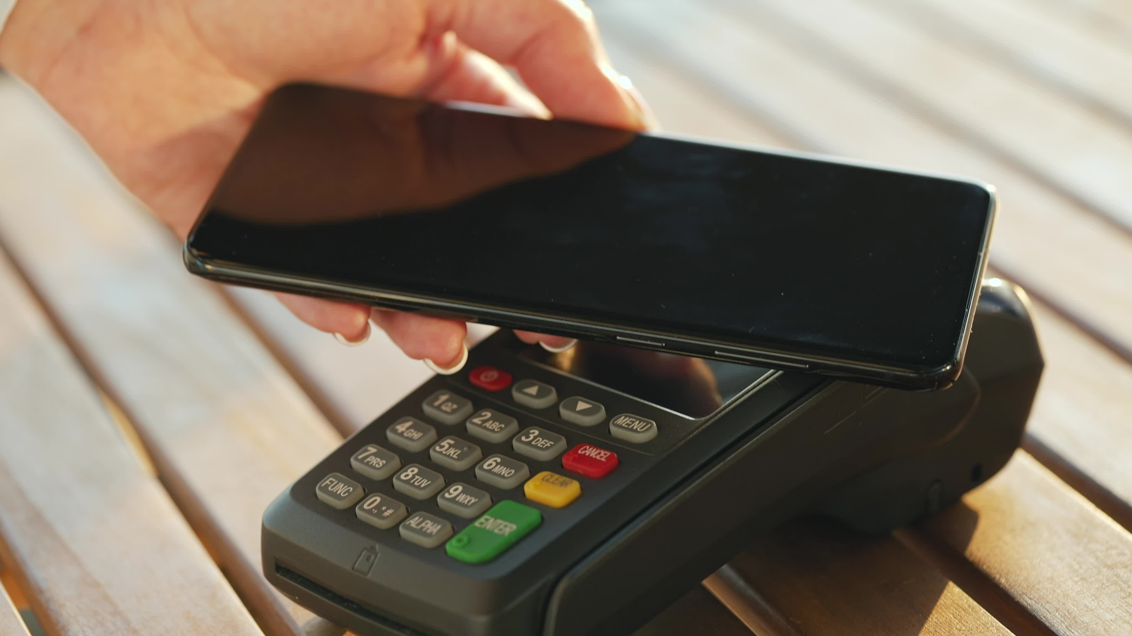 NFC credit card payment. Woman paying with contactless credit card with ... NFC credit card payment. Woman paying with contactless credit card with ...