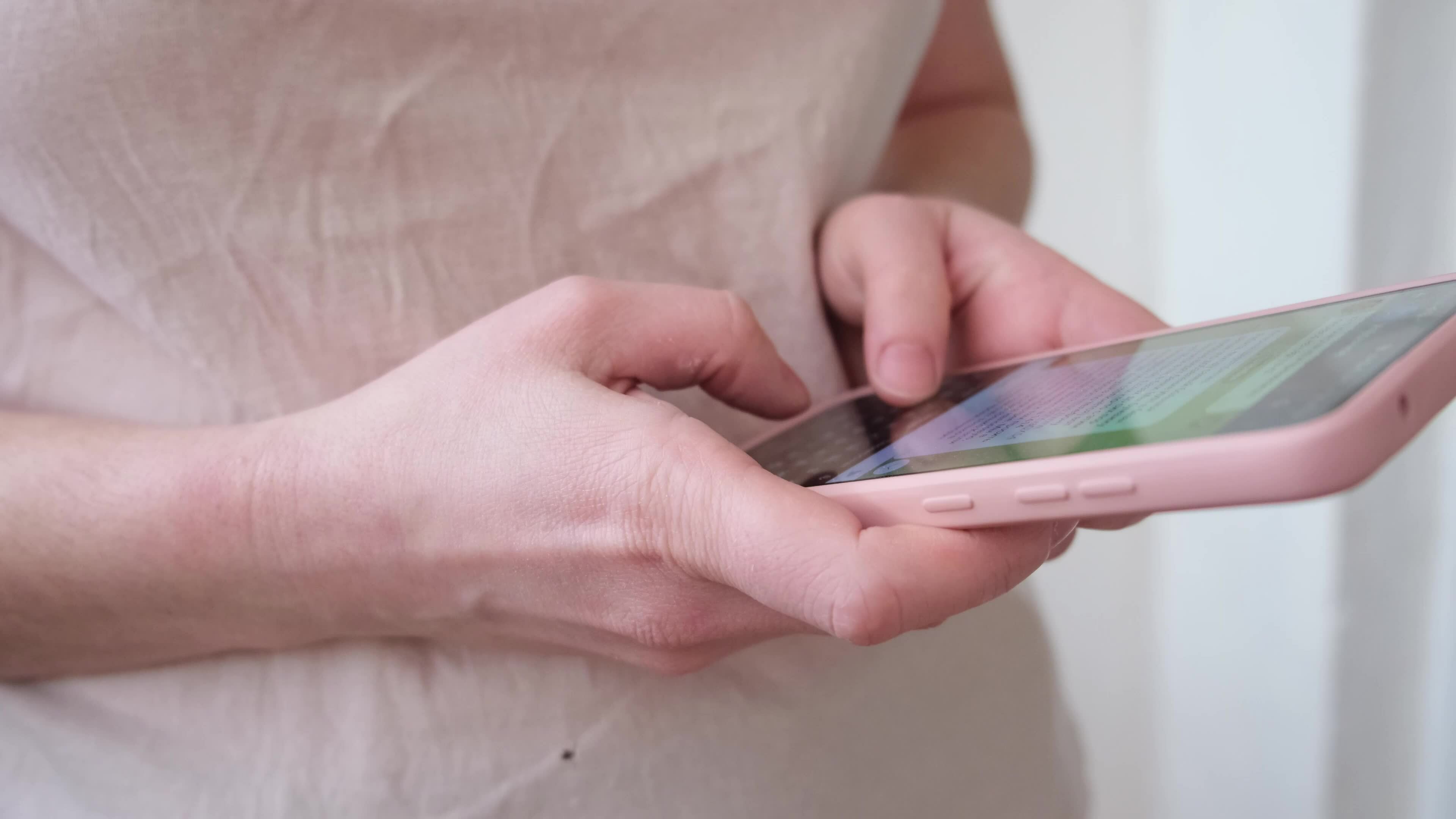 Woman hand holding cell phone touch screen typing scroll page using app. Smartphone mobile phone ...