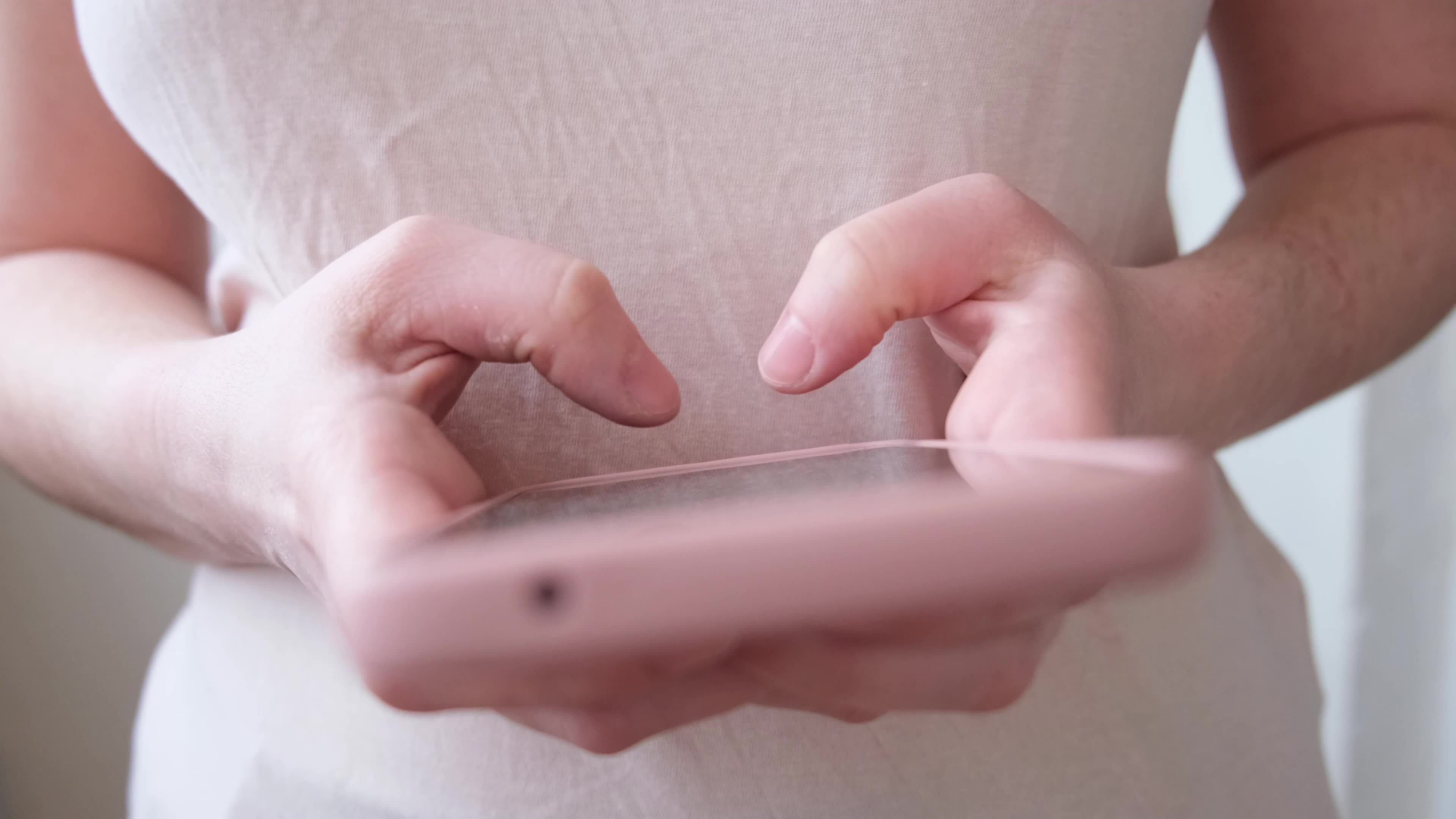 Woman hand holding cell phone touch screen typing scroll page using app. Smartphone mobile phone ...