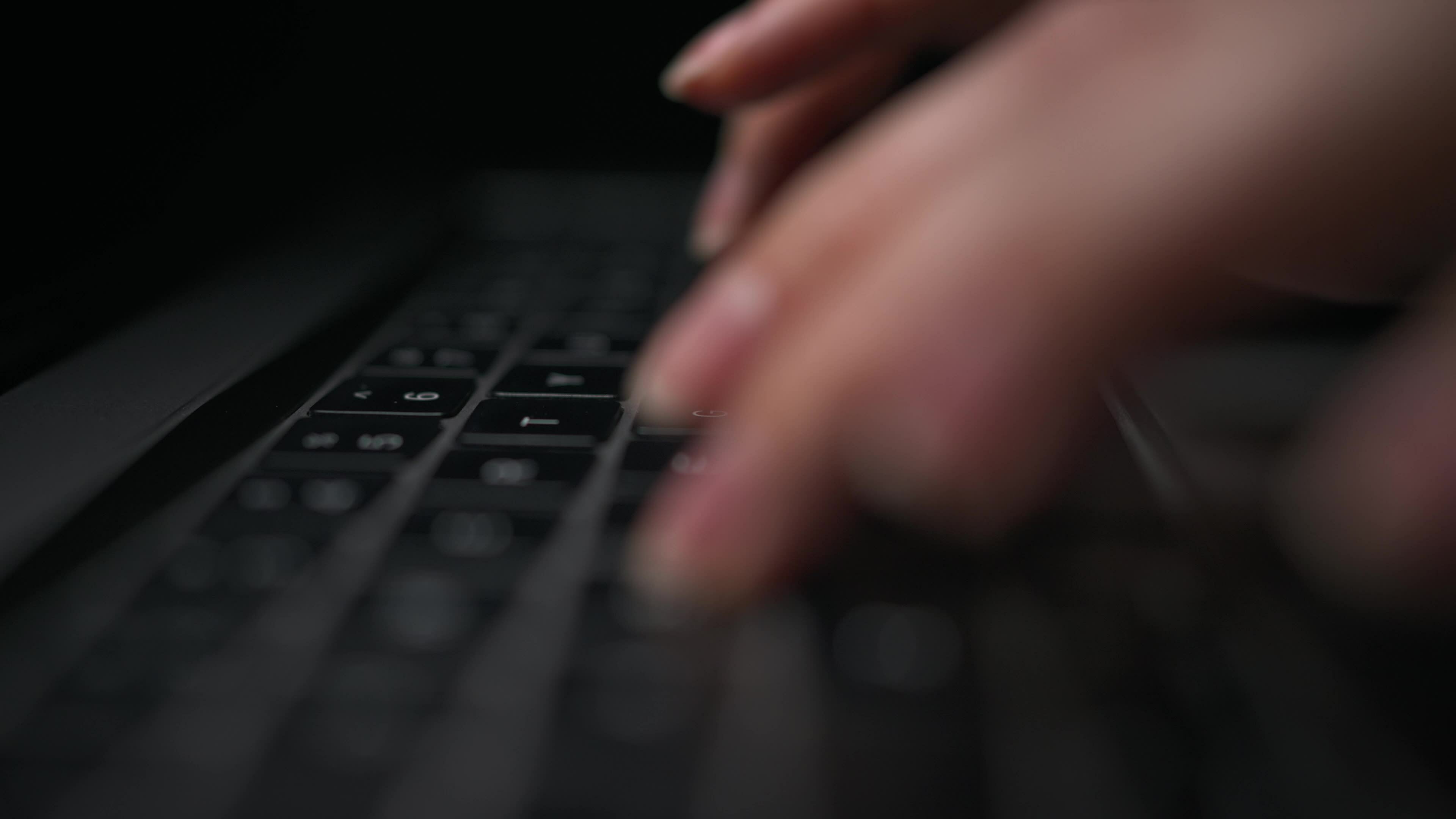Macro close-up of female hands busy working on laptop or computer keyboard for send emails and ...