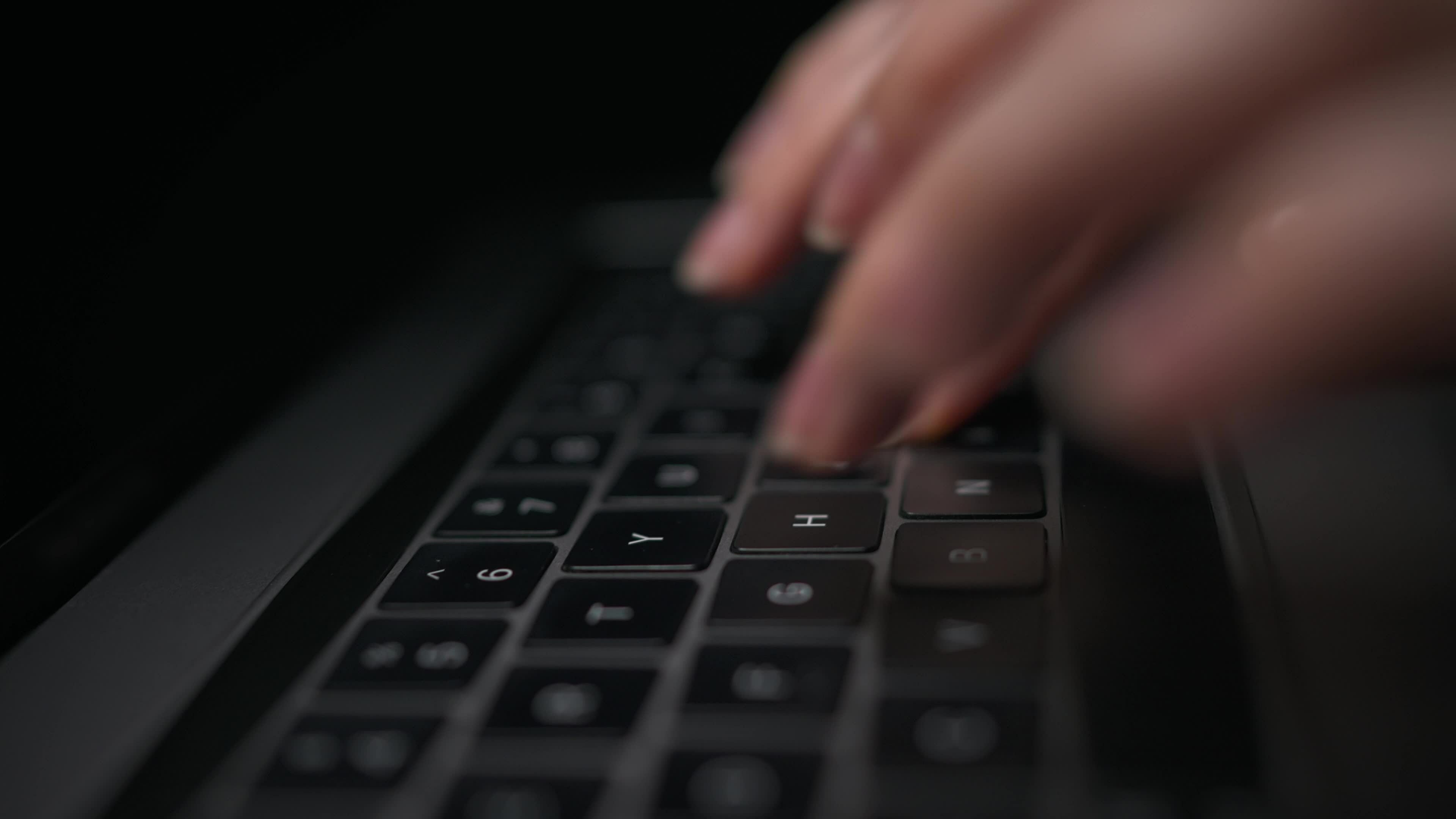 Macro close-up of female hands busy working on laptop or computer keyboard for send emails and ...