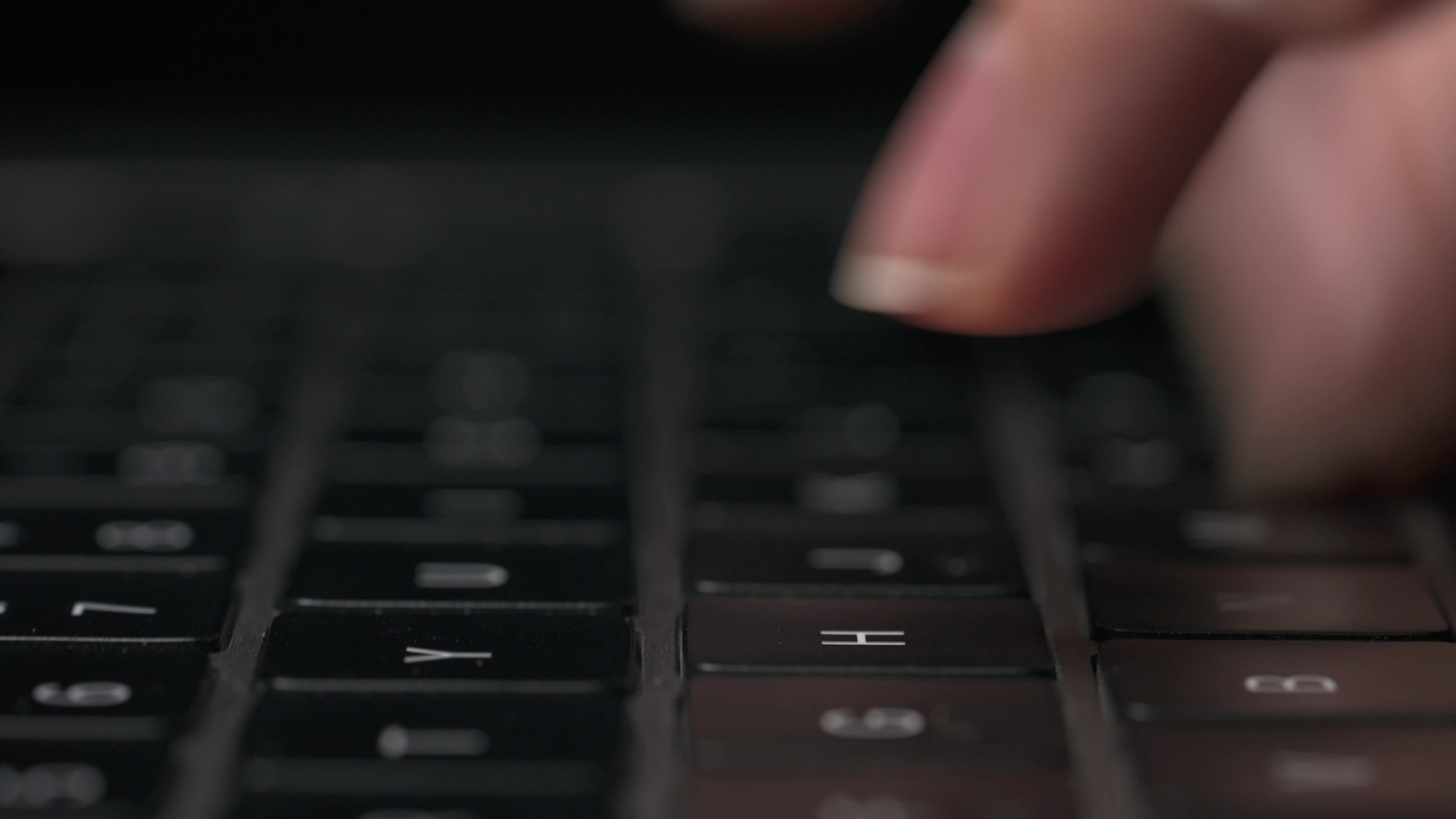 Macro close-up of female hands busy working on laptop or computer ...