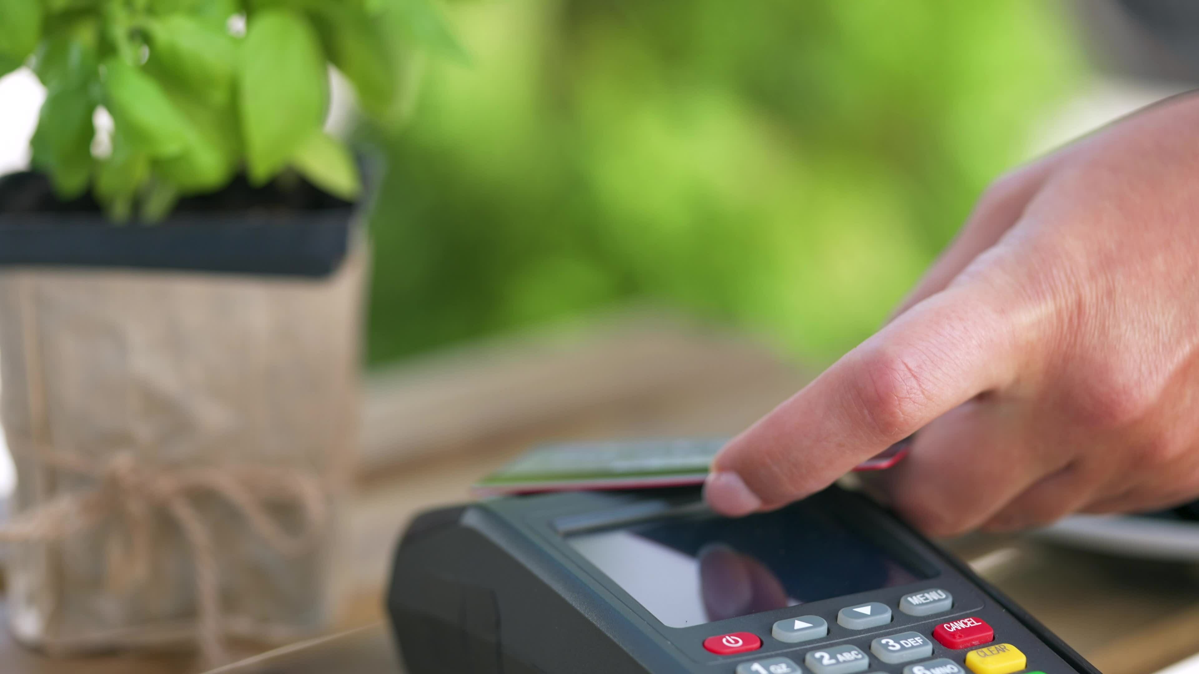 NFC credit card payment. Woman paying with contactless credit card with ... NFC credit card payment. Woman paying with contactless credit card with ...