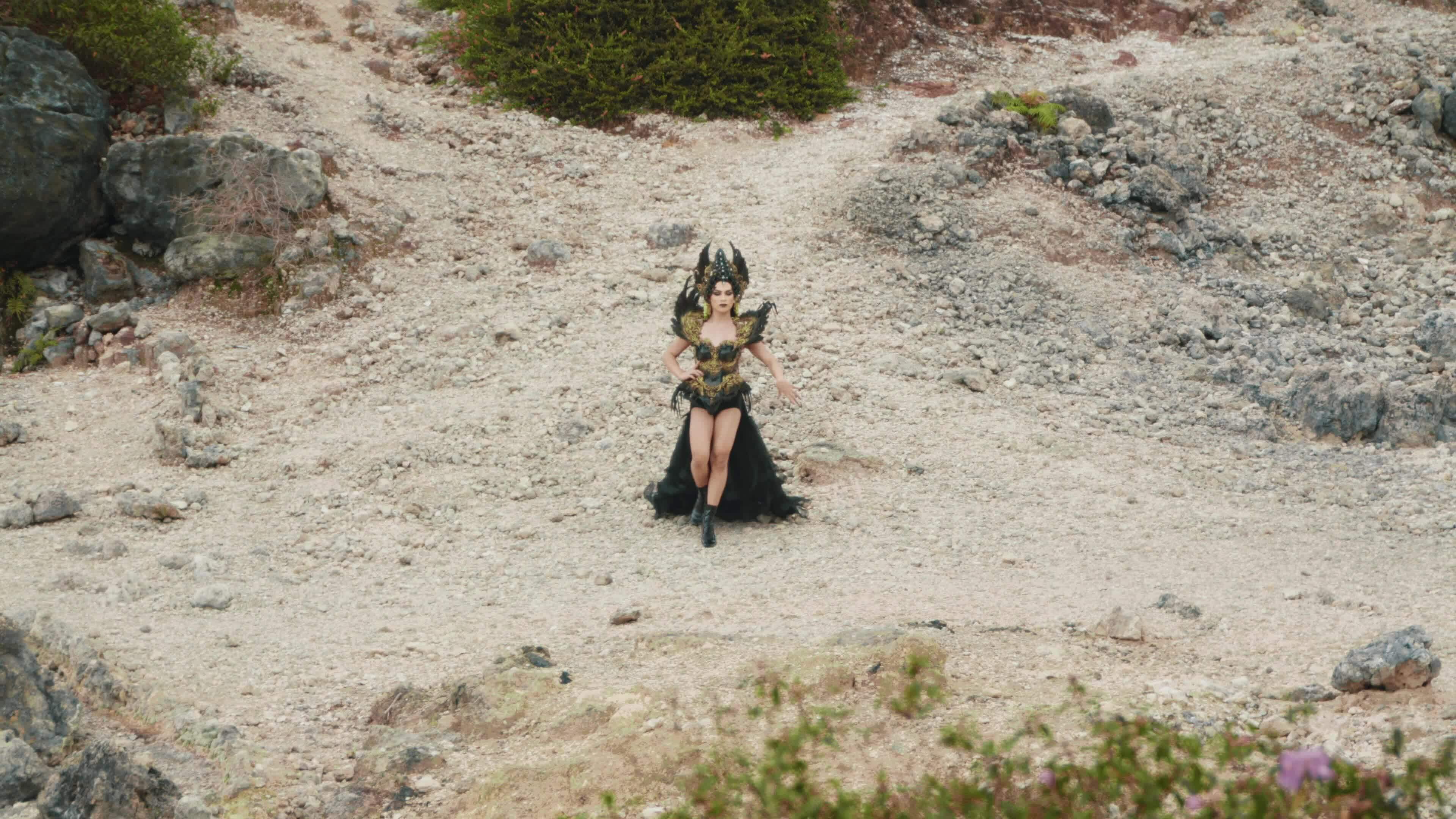 a gothic woman in a black dress walking in a mountain crater filled ... a gothic woman in a black dress walking in a mountain crater filled ...
