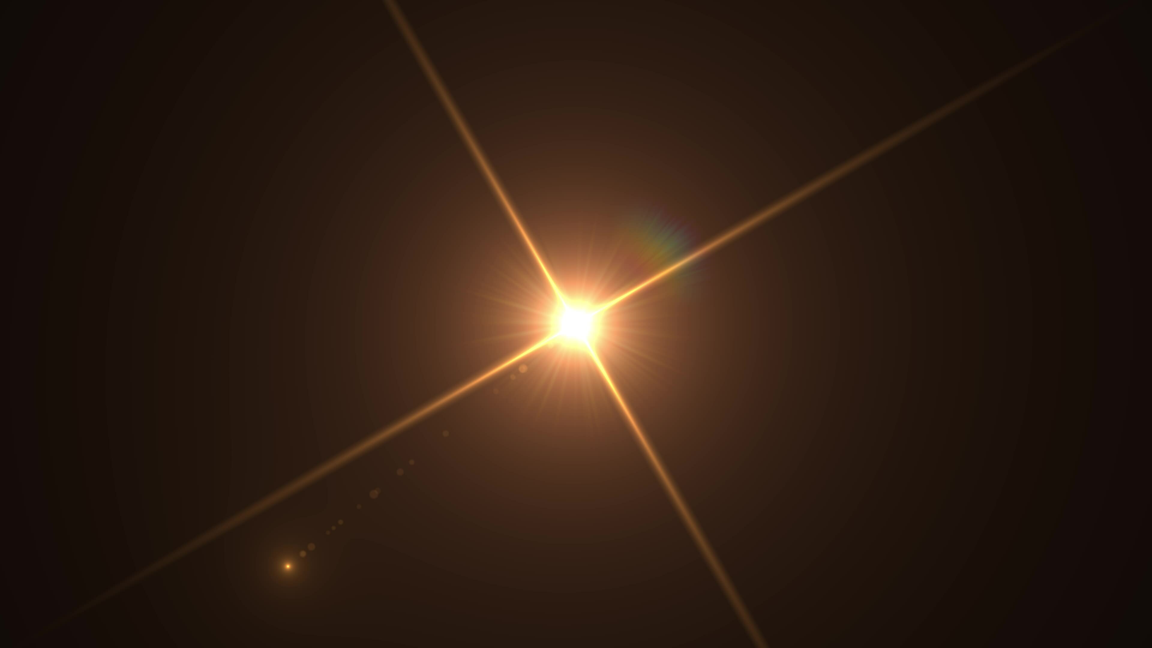 Orange color glint lens flare rotation with increase glow intensity. 2D computer rendering ...