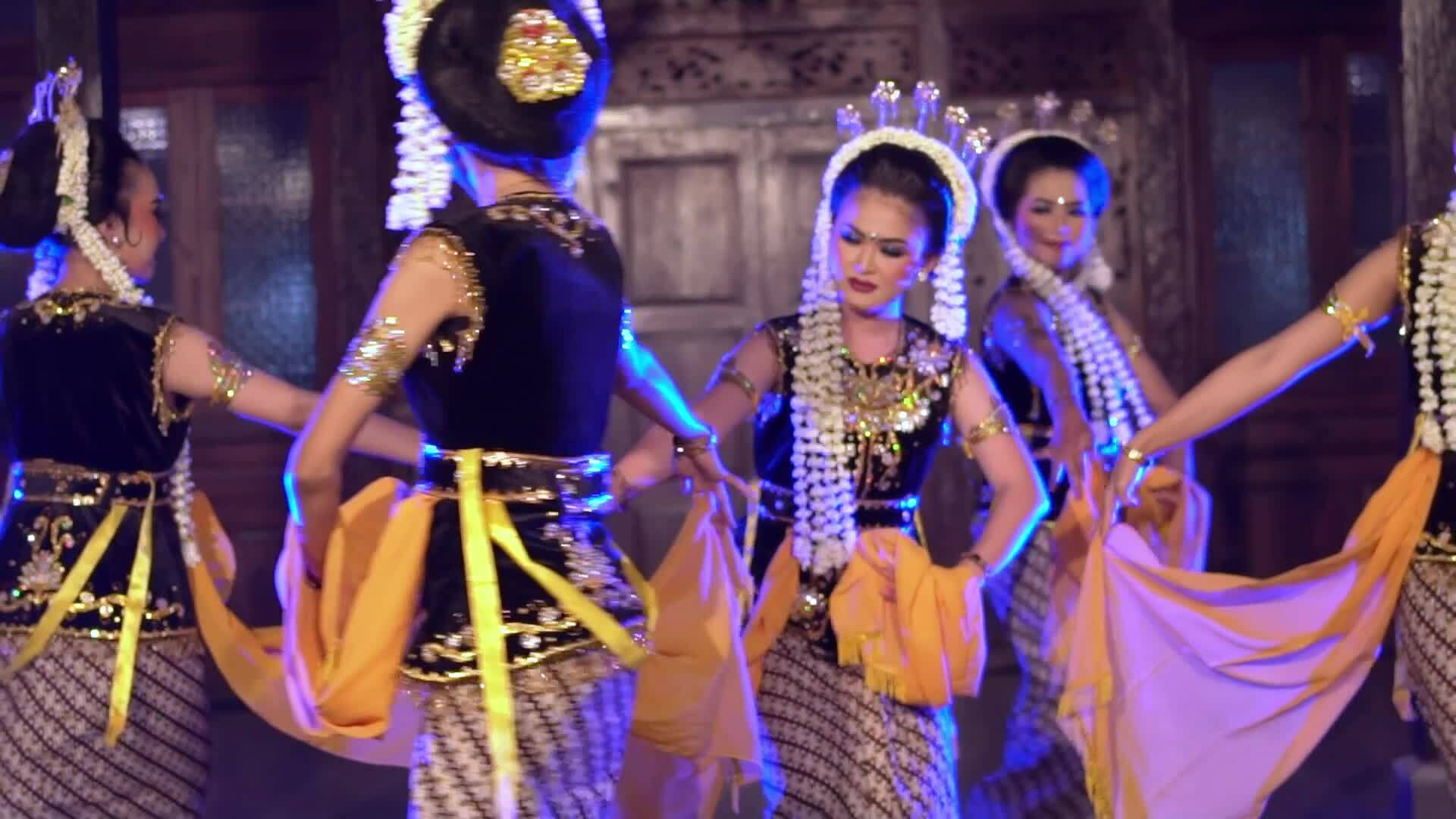 a group of Javanese dancers dances on a stage very softly and beautifully when wearing jasmine ...