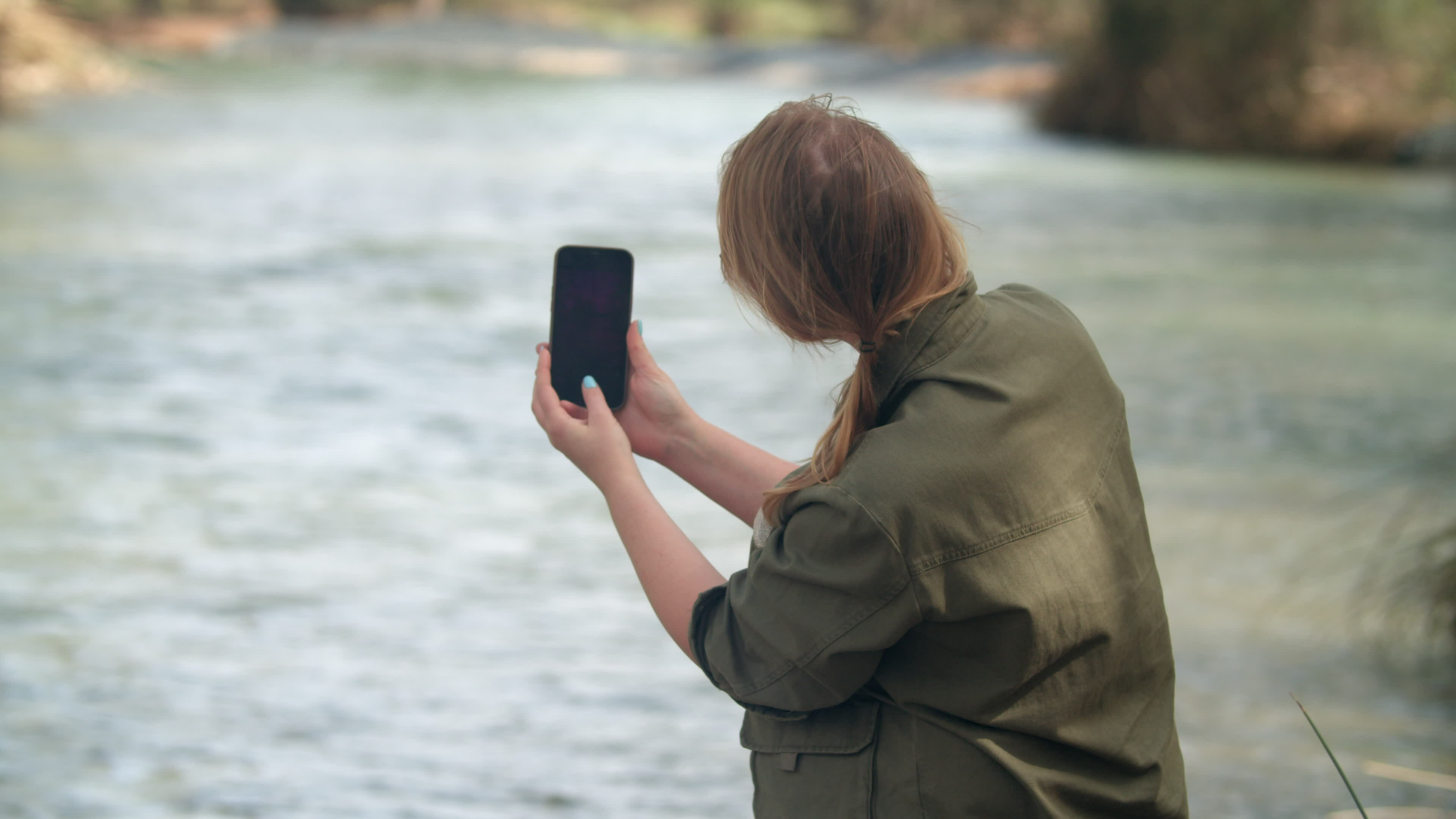 Woman with smartphone taking pictures of the river 28594201 Stock Video ...