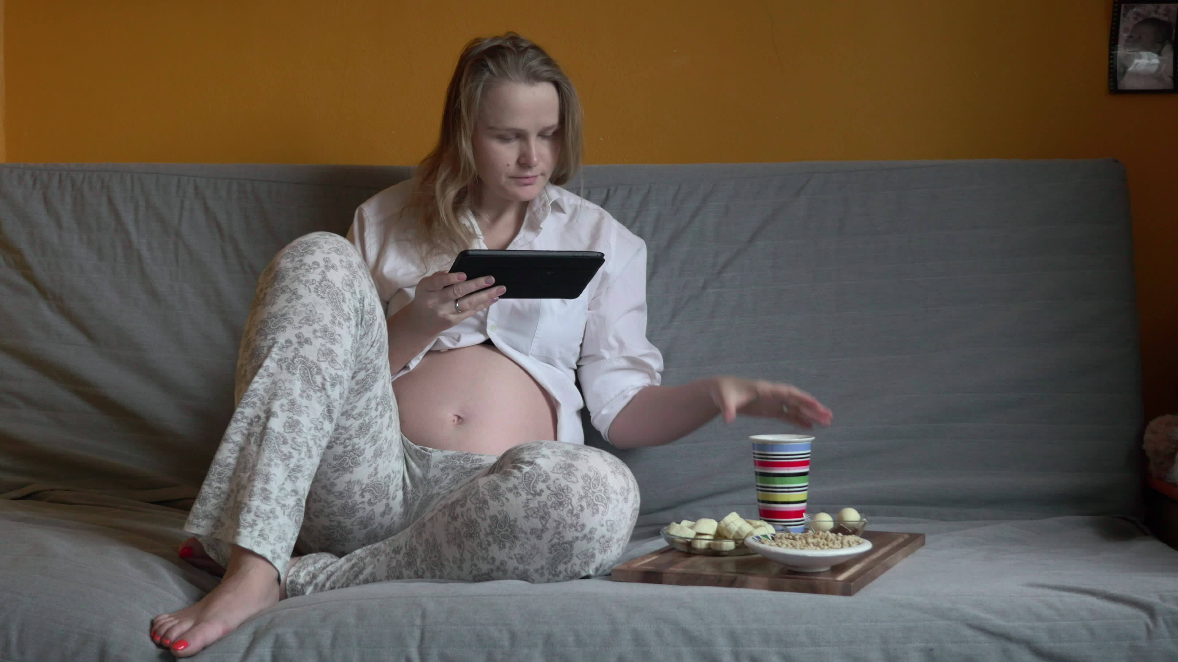 Pregnant woman chilling on a sofa 28772744 Stock Video at Vecteezy