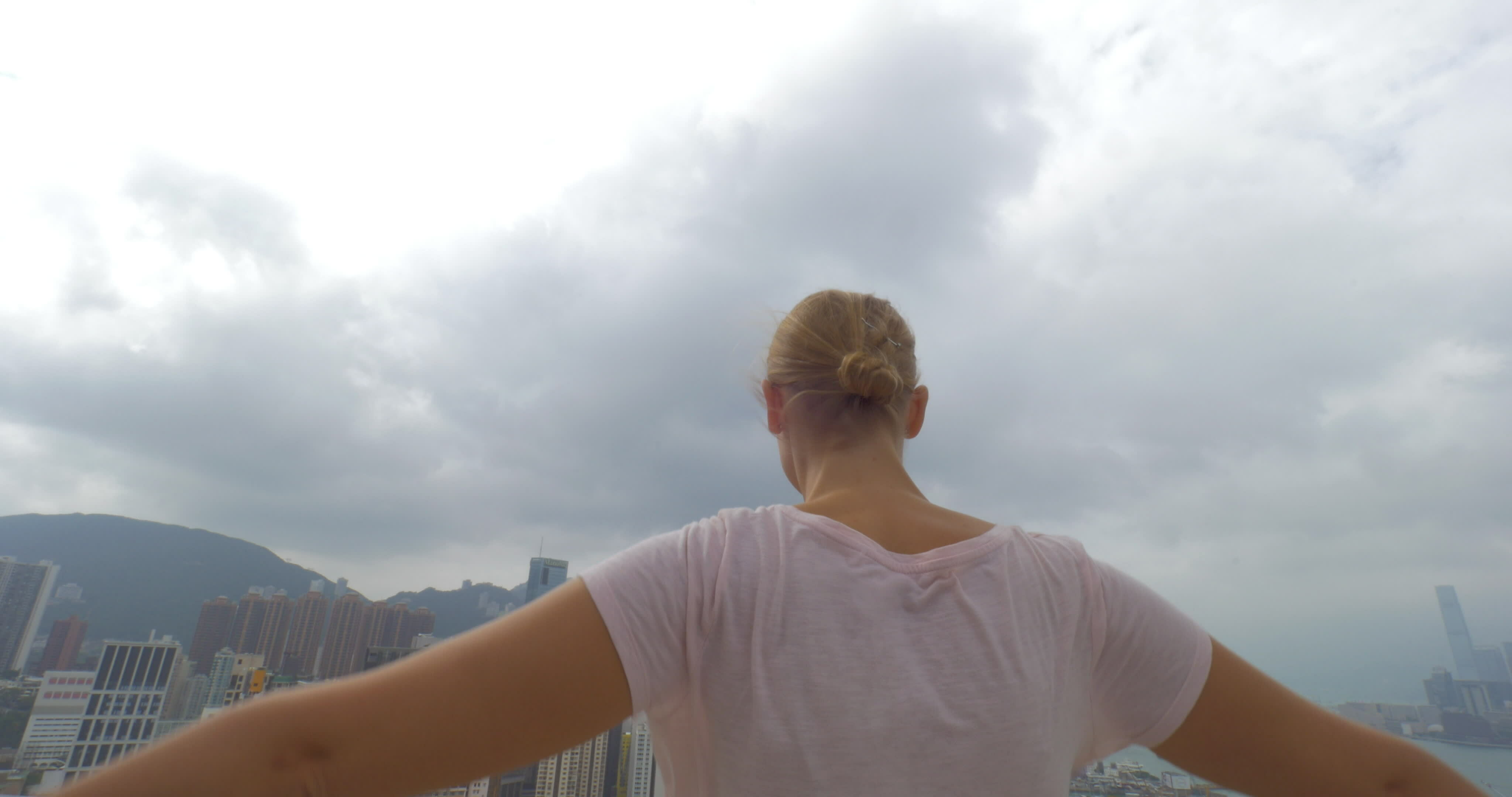 In Hong Kong China On The Terrace A Young Girl Does Exercises With Dumbbells Spreading Hands