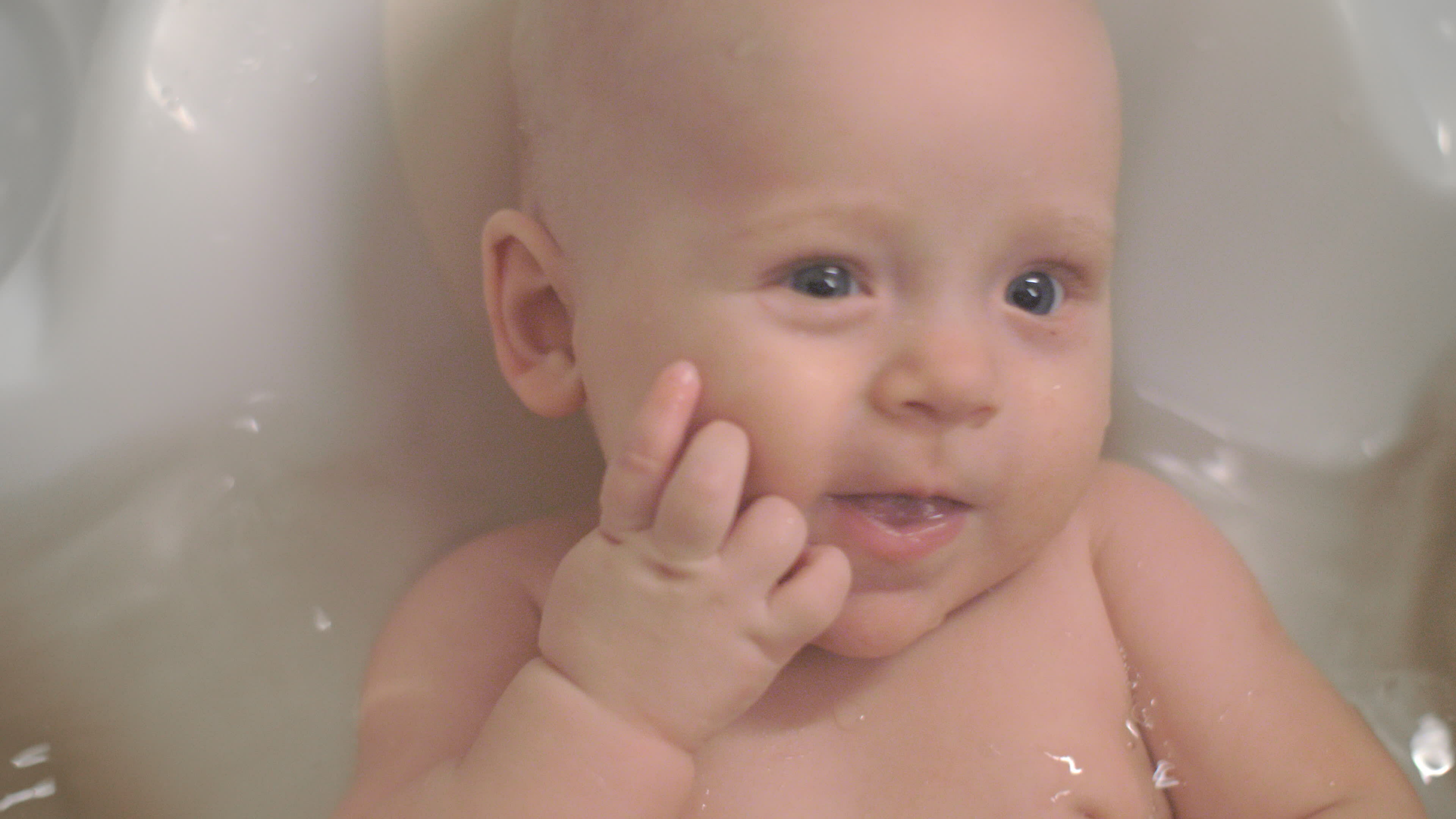A closeup of a baby girl enjoying bathing 30248317 Stock Video at Vecteezy