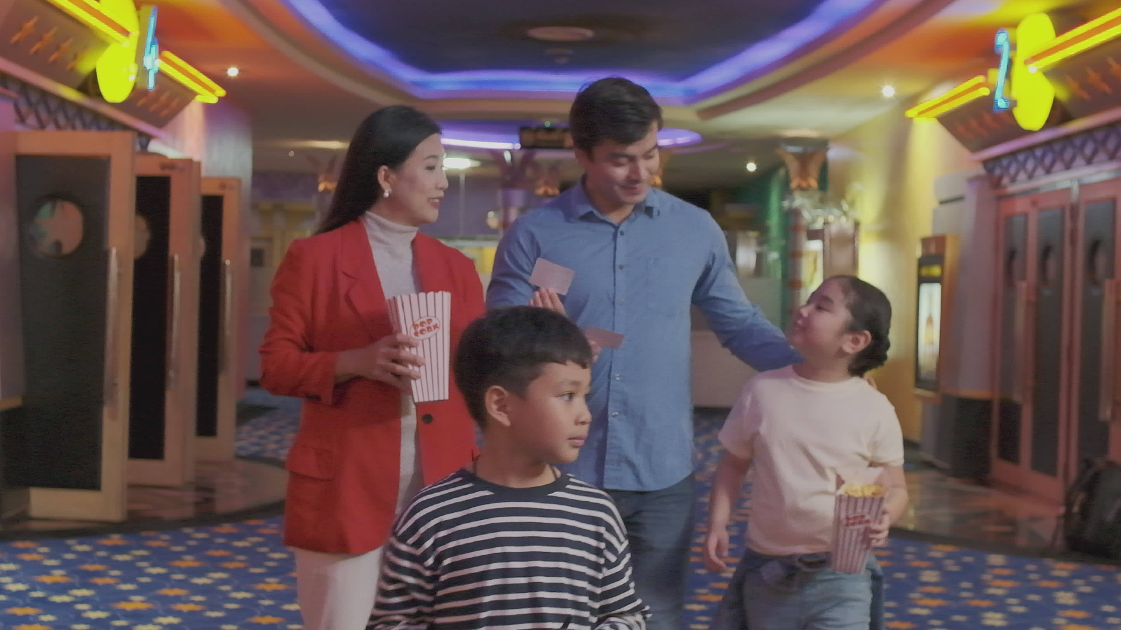 Asian family audiences come to movies when theater opens and cinema shows, enjoy walking ...