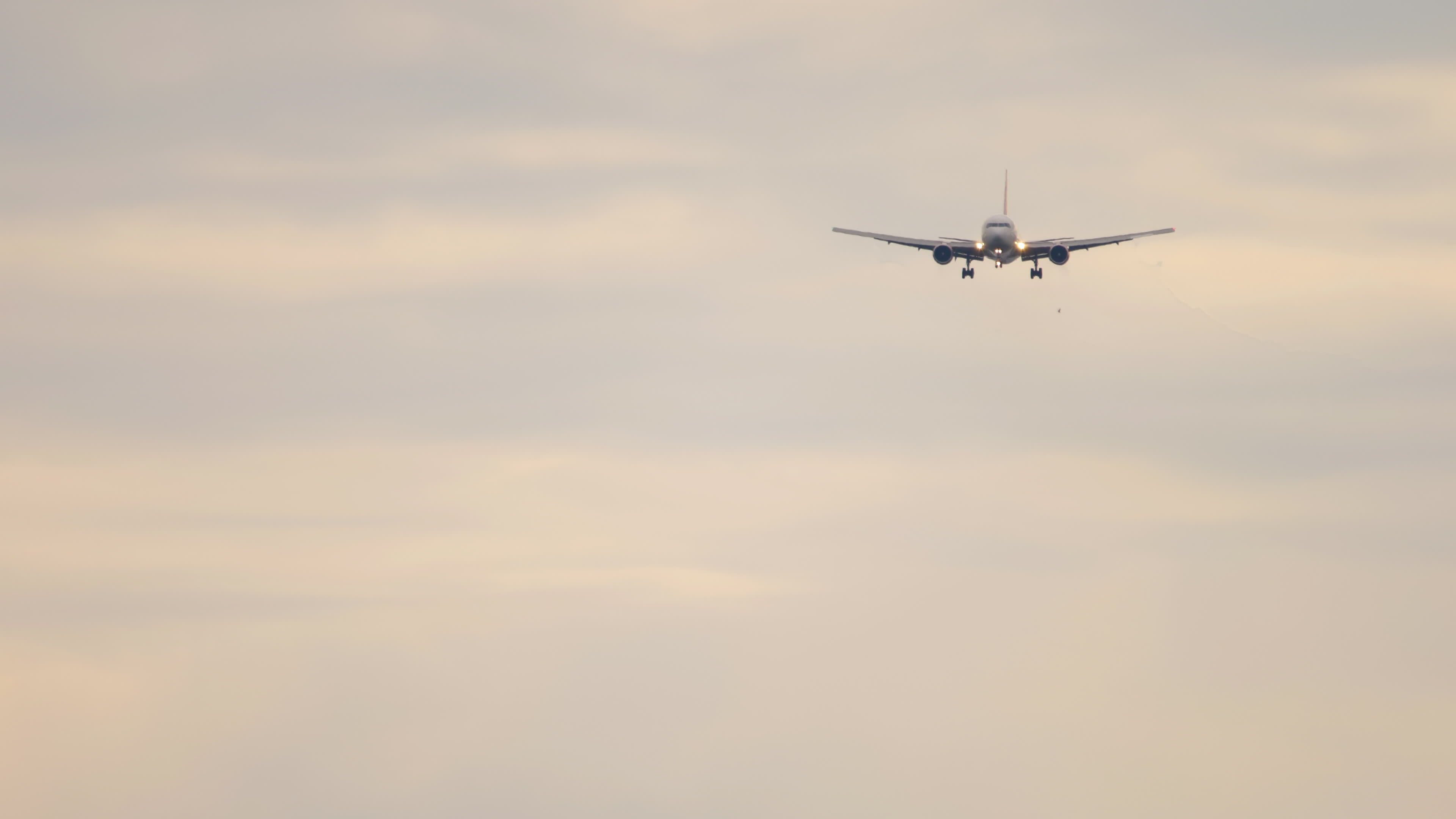 Jet Plane Approaching Landing In The Sunset Sky View From Below