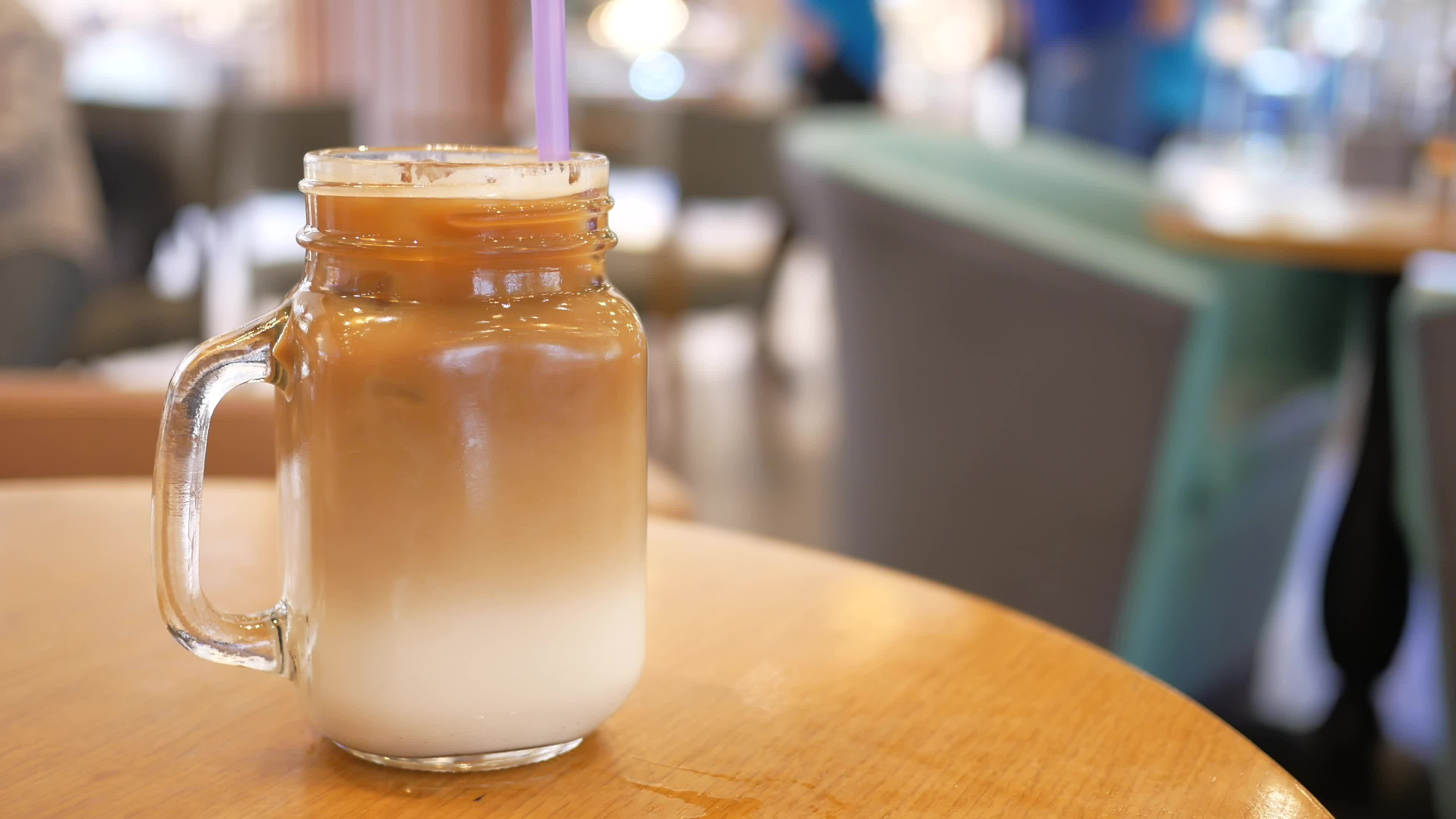 iced late in a transparent glass on cafe table outdoor 30821734 Stock Video at Vecteezy
