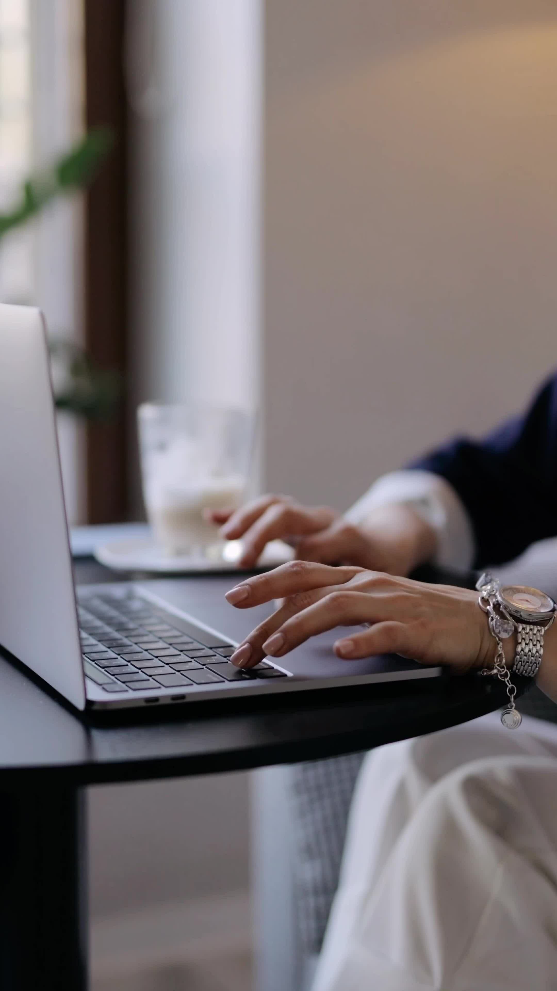 Close up of Woman's hands using a laptop trackpad scrolling website for shopping online and ...