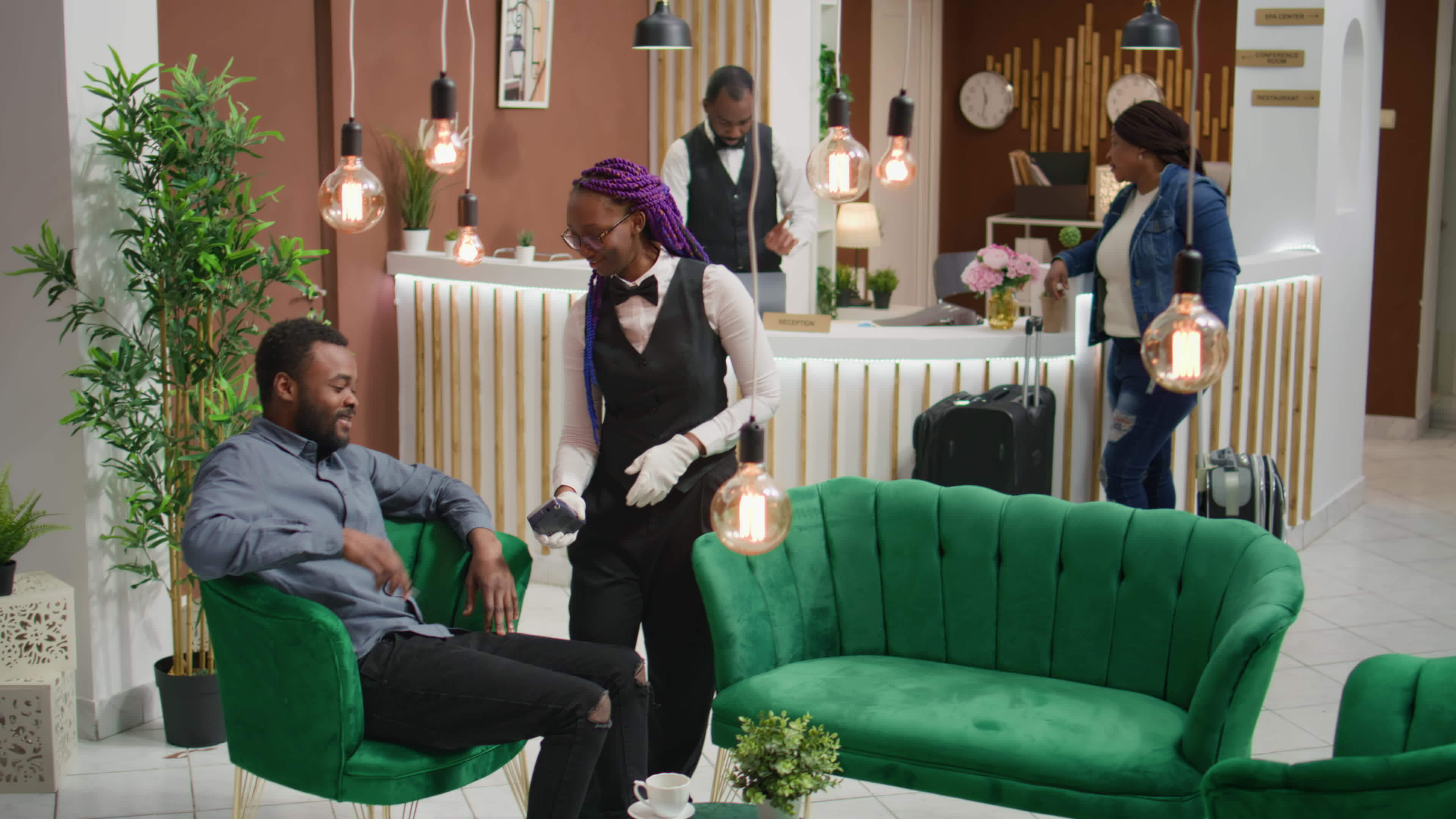 Customer buys cup of coffee in lobby from hotel bar using card at pos terminal. Guest shows ...