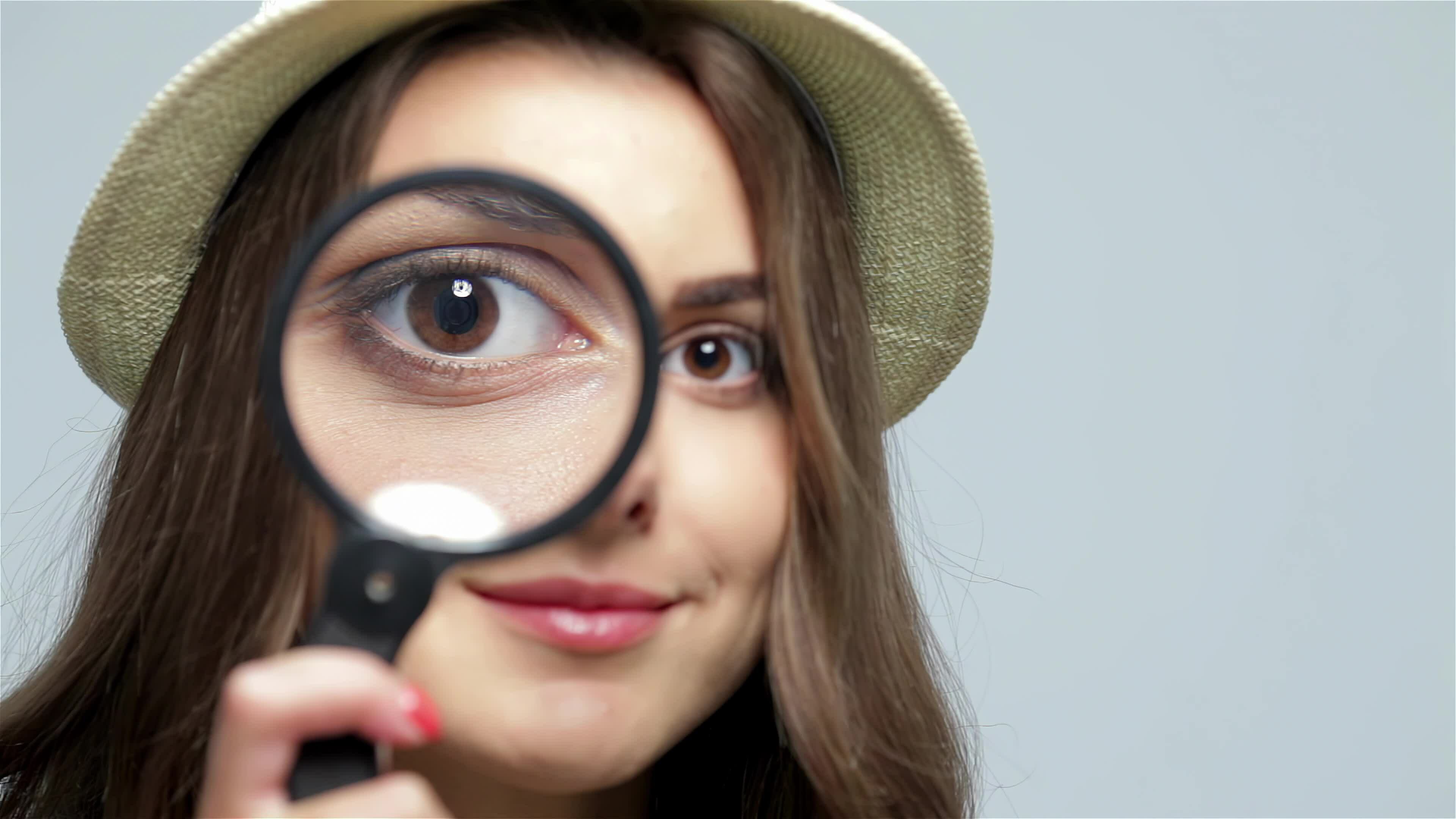 Beautiful girl with loupe zooming her eye 31727651 Stock Video at Vecteezy