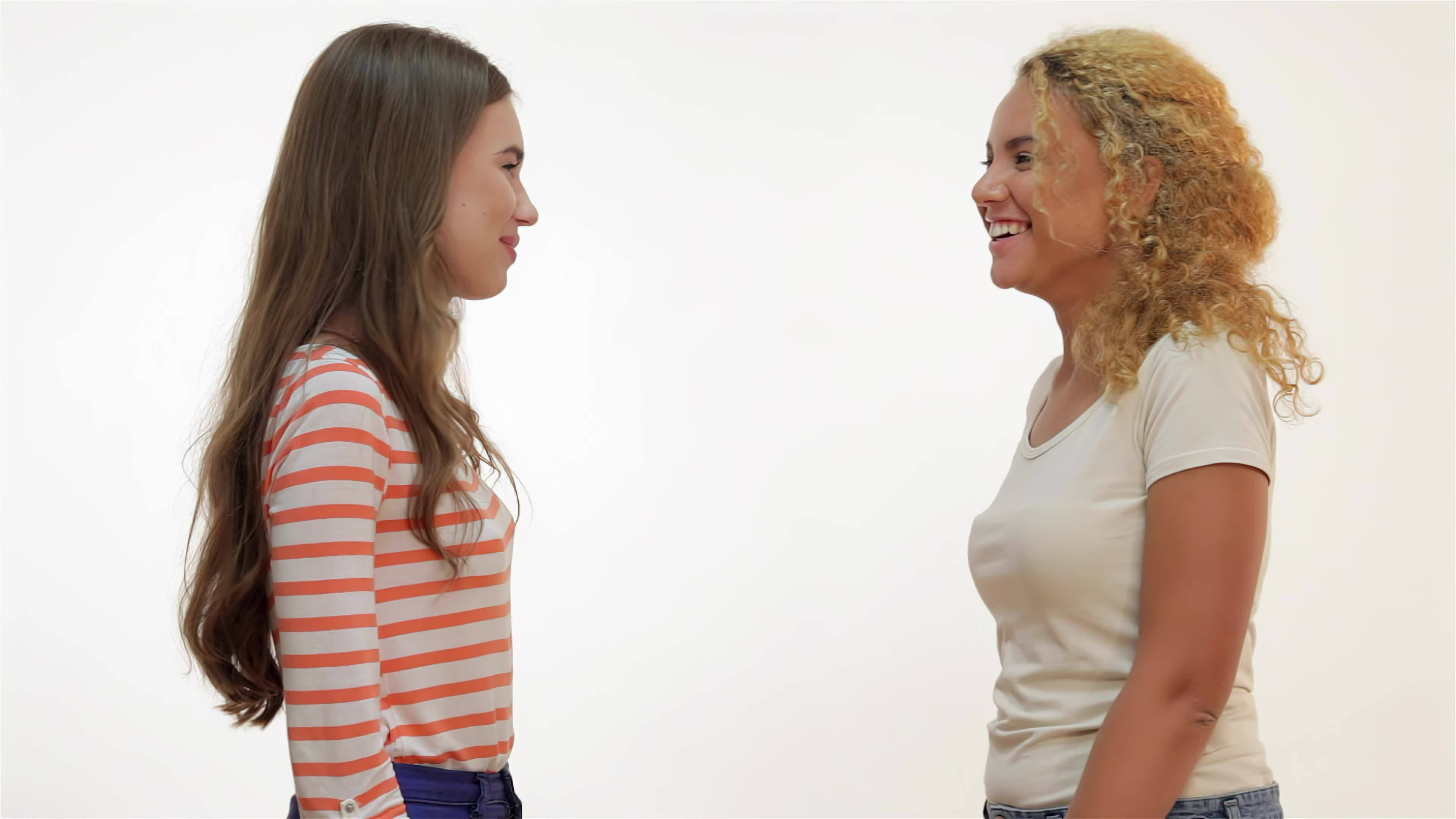 Attractive young girls smile and clap each other palms 31759103 Stock Video at Vecteezy