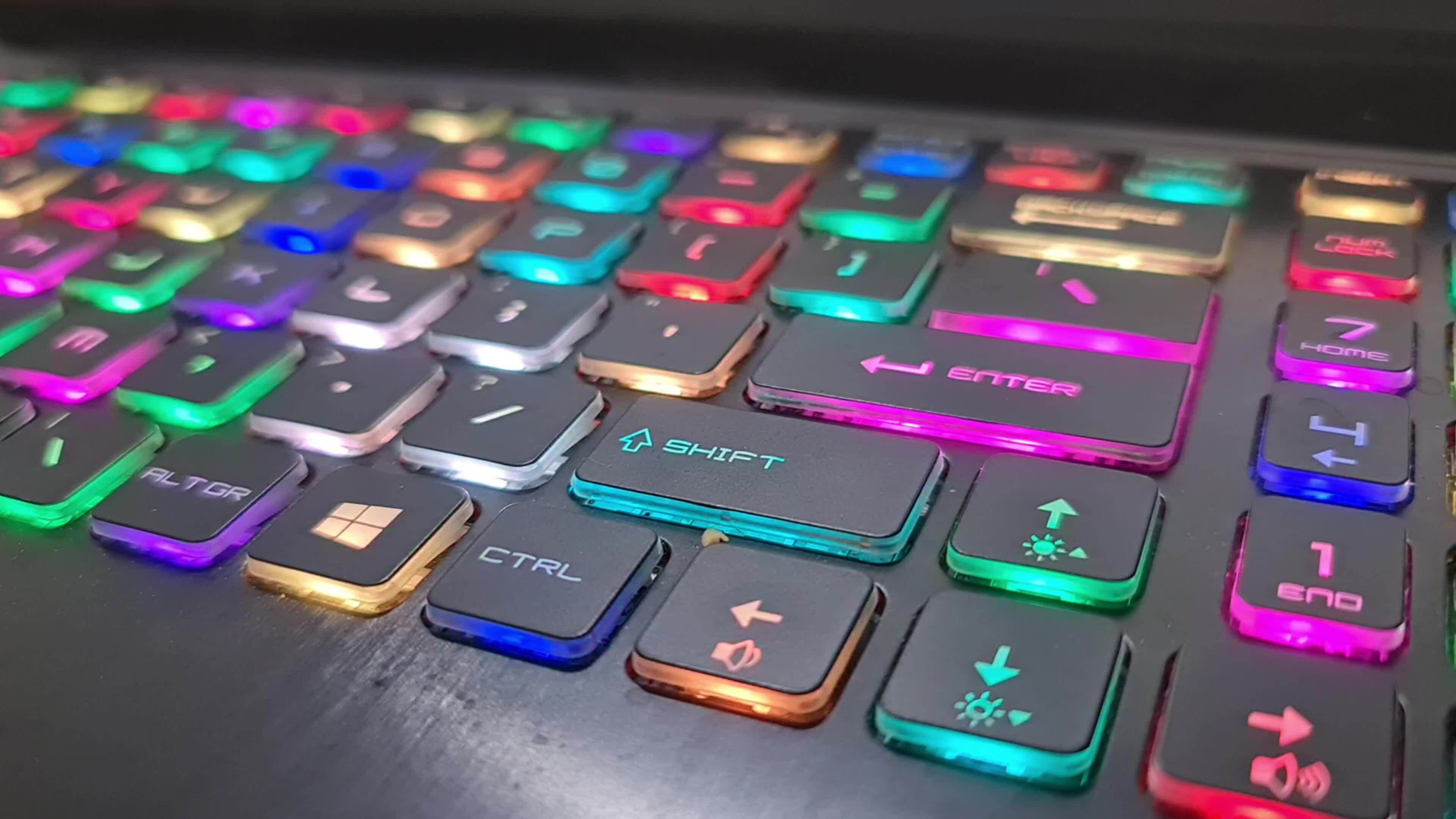 A gaming keyboard that has colorful LED lights, with the main color of ...