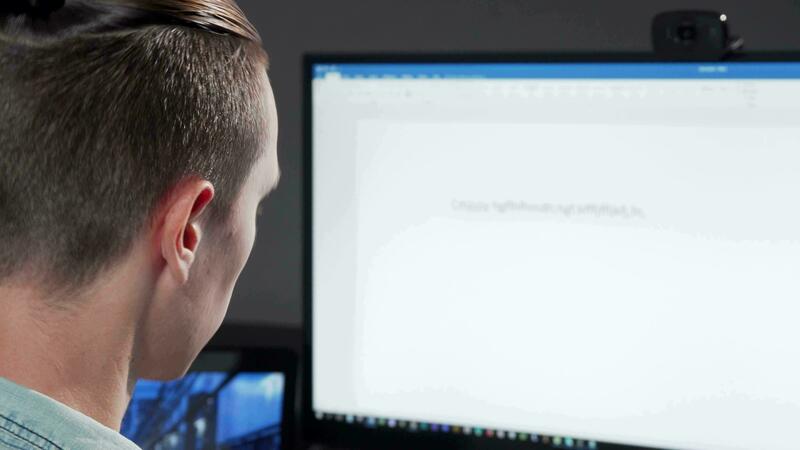 Rear view cropped shot of a computer programmer working late in IT ...