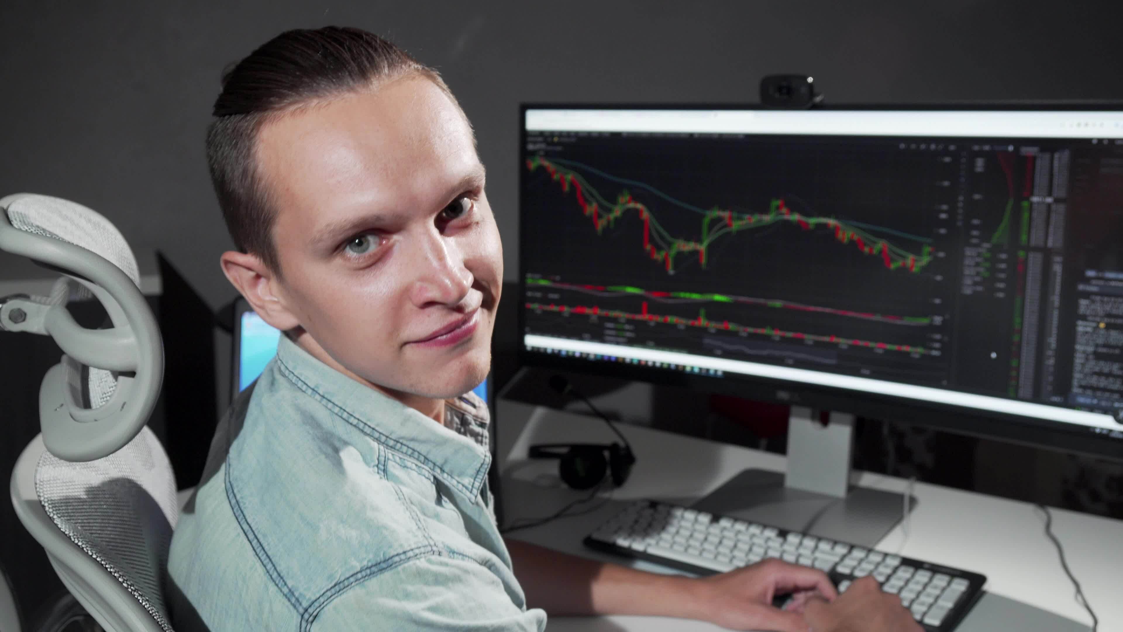 Male computer programmer smiling to the camera while working late at ...