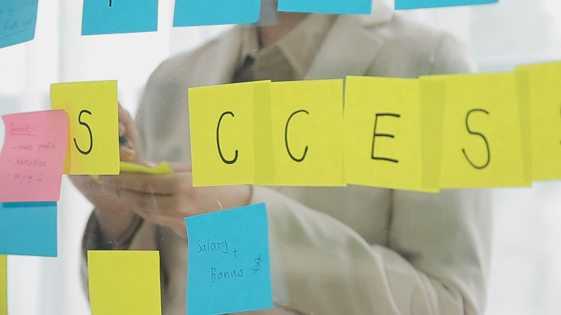 Business people meeting at office writing memos on sticky notes ...