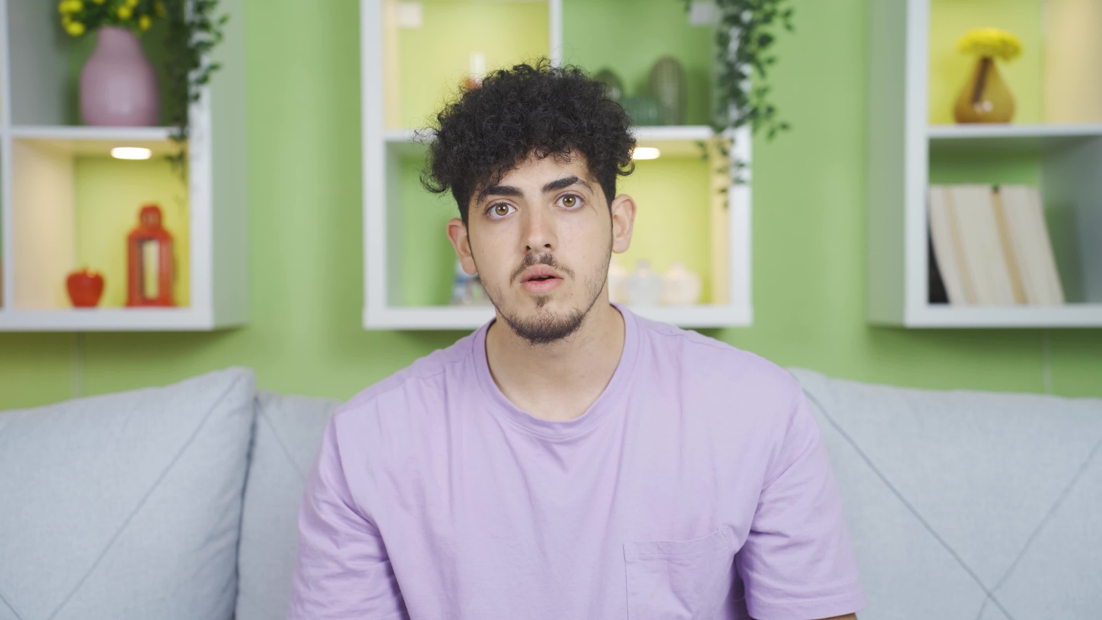 Young man looking at camera with admiration. He is surprised by the ...