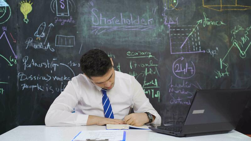 Businessman writes Shareholder on the board and thinks. 32966329 Stock ...