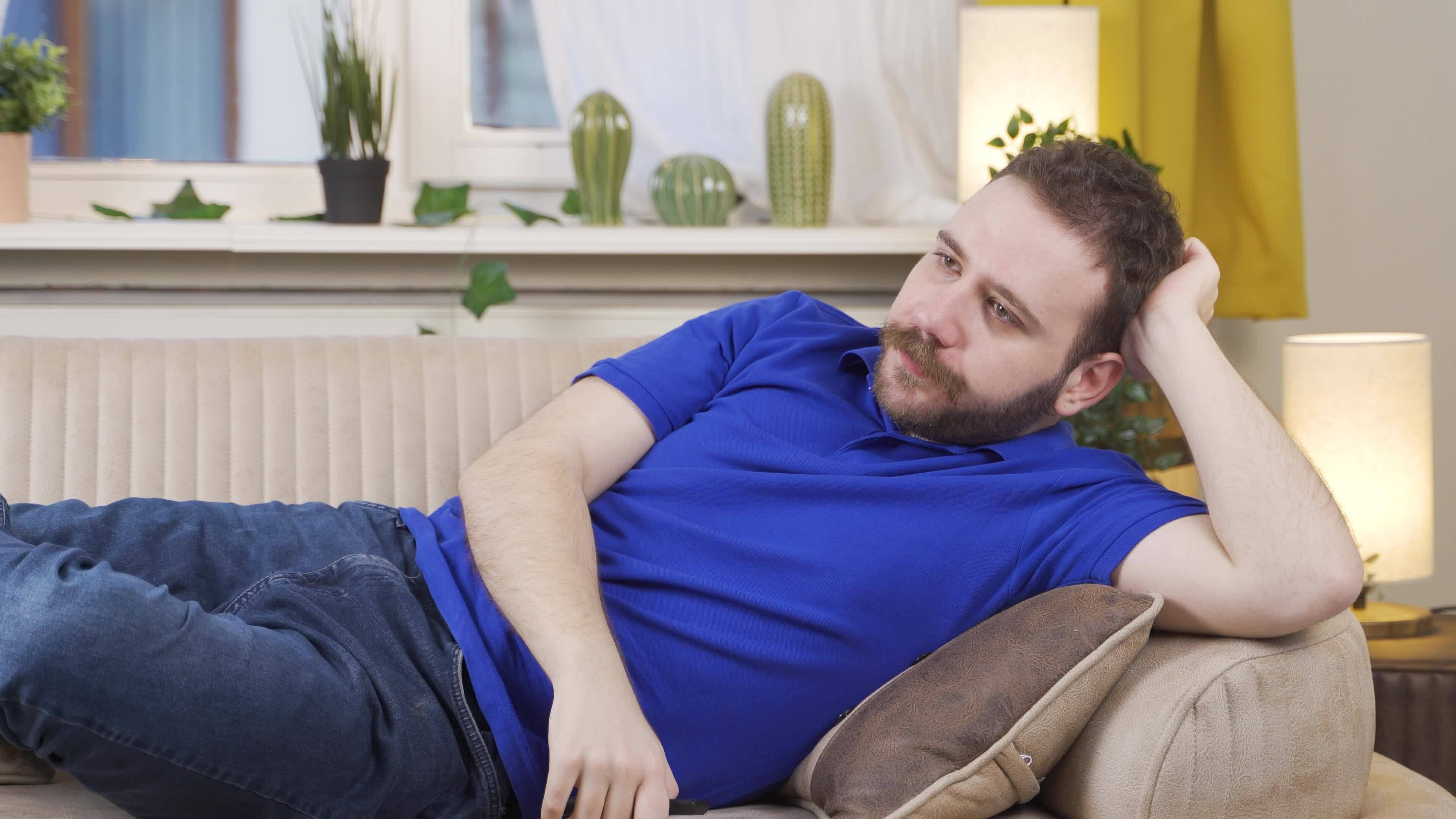 Man lying on the sofa is resting. 32966375 Stock Video at Vecteezy