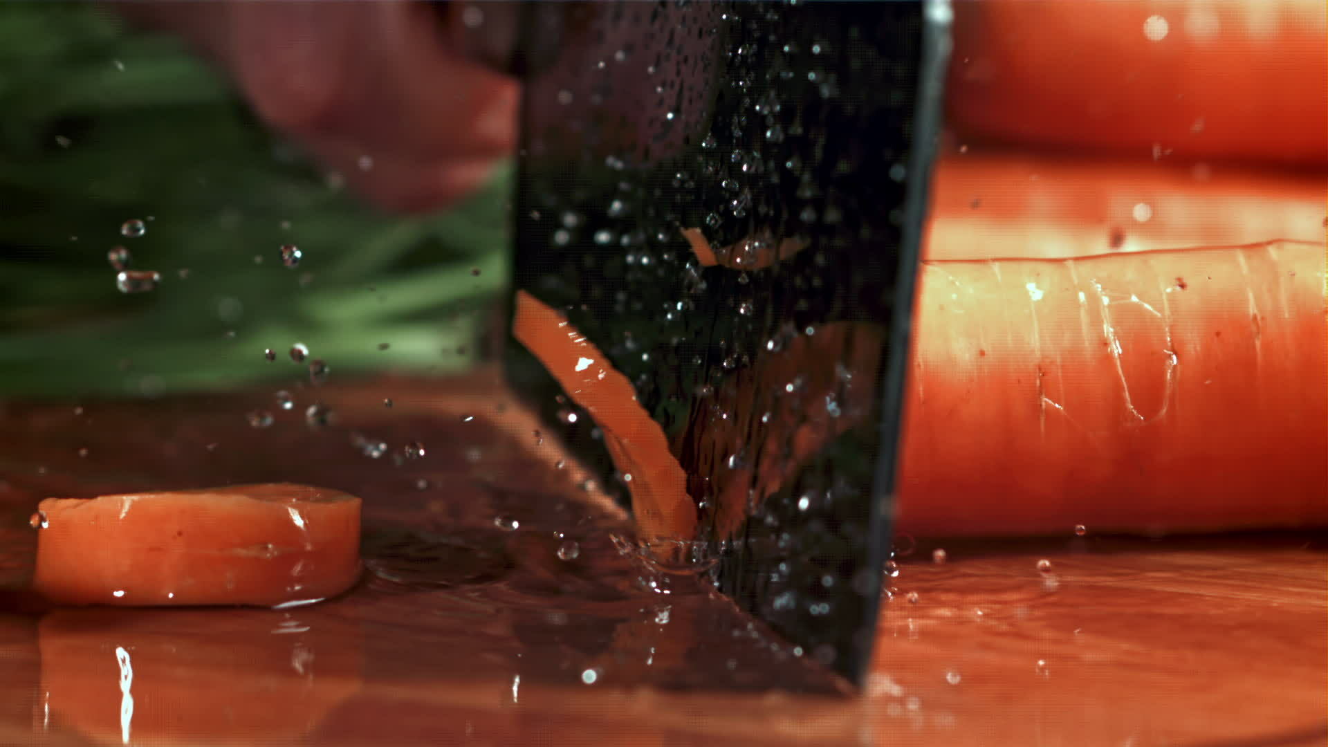 Knife Cuts Carrots With Splashes Filmed On A Highspeed Camera At 1000 Fps High Quality Fullhd