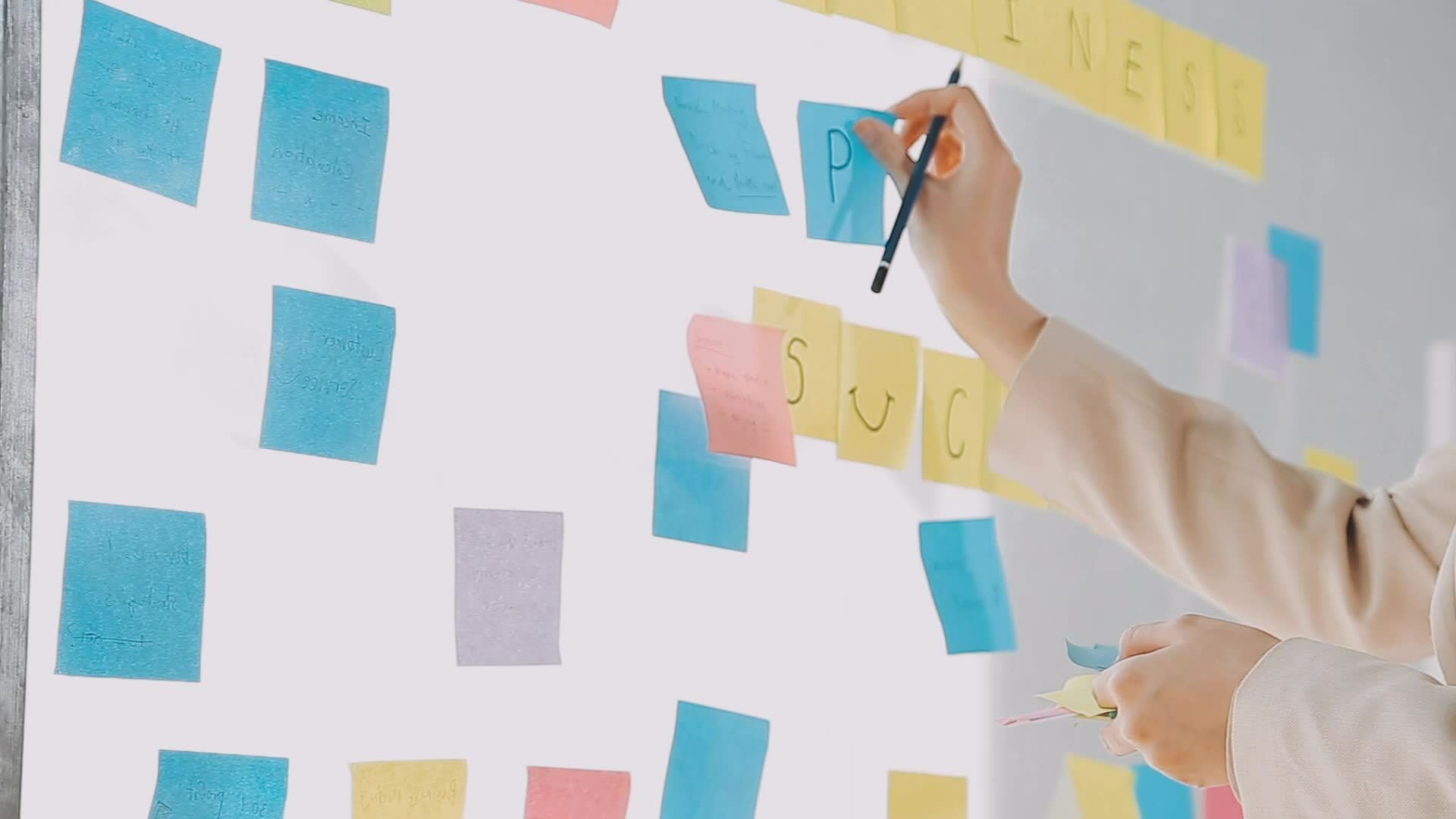 Business people meeting at office writing memos on sticky notes ...