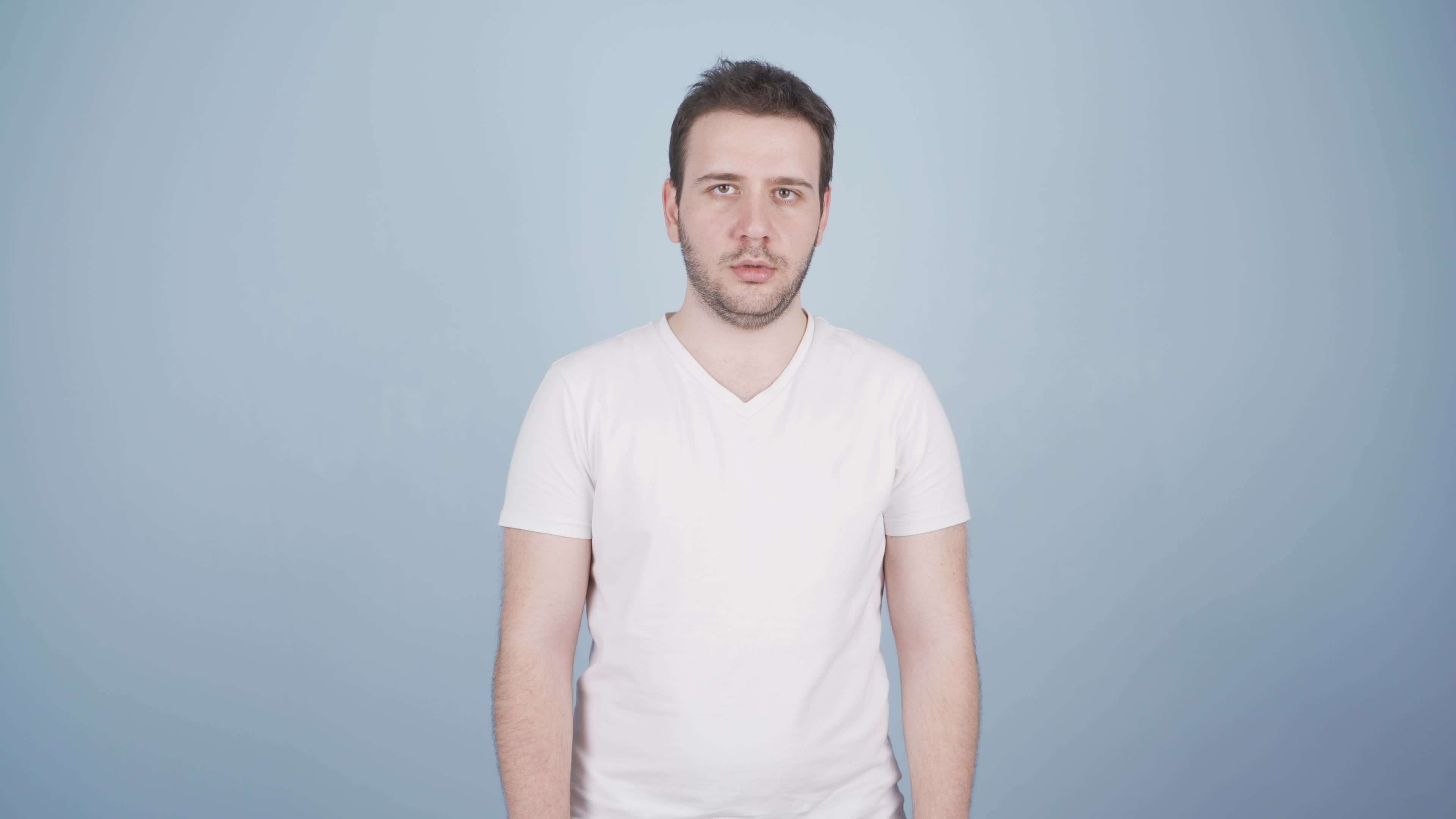 Man looking at camera with dull expression. 33029039 Stock Video at ...