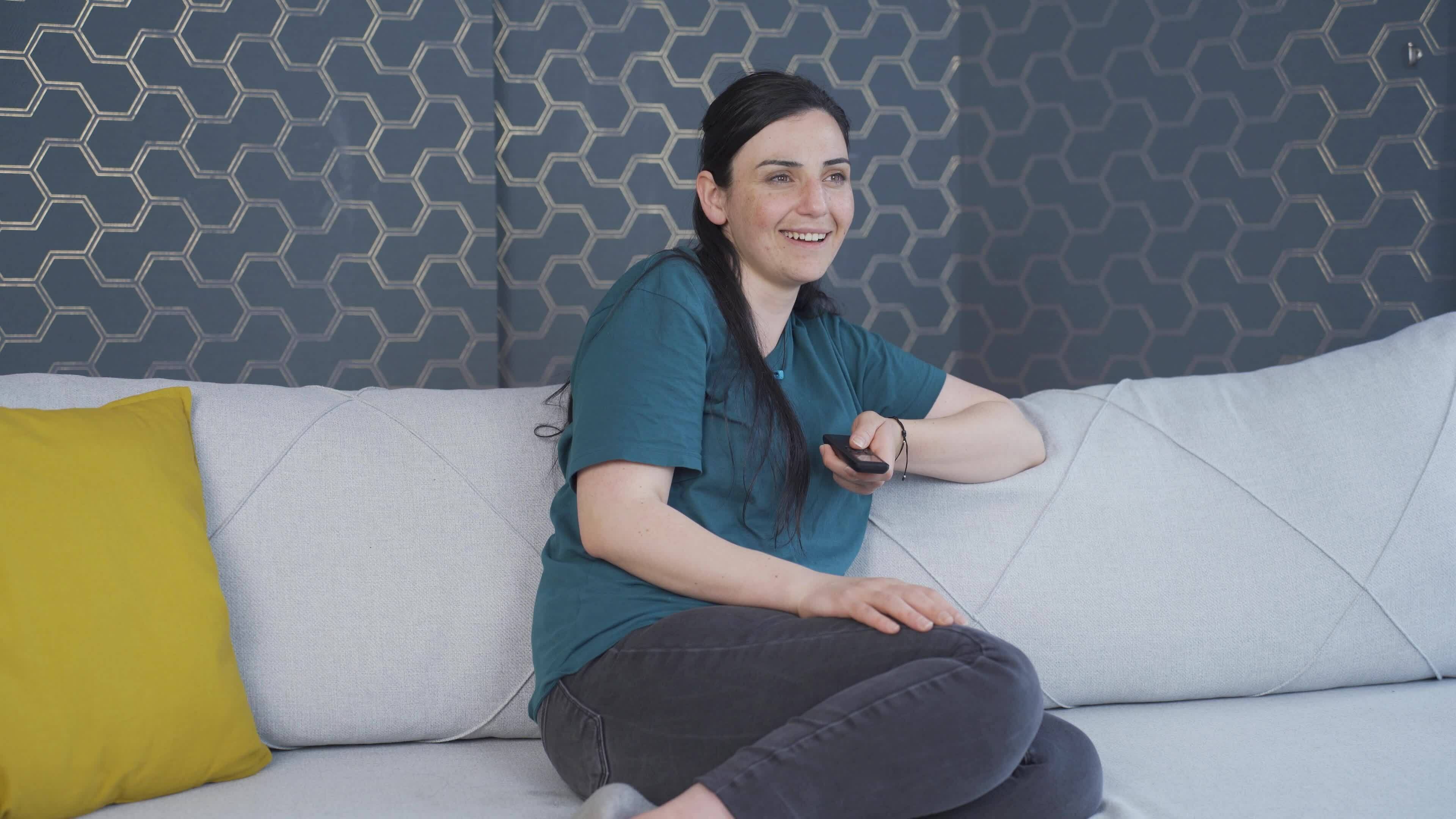 The woman watching television rejoices. 33057052 Stock Video at Vecteezy